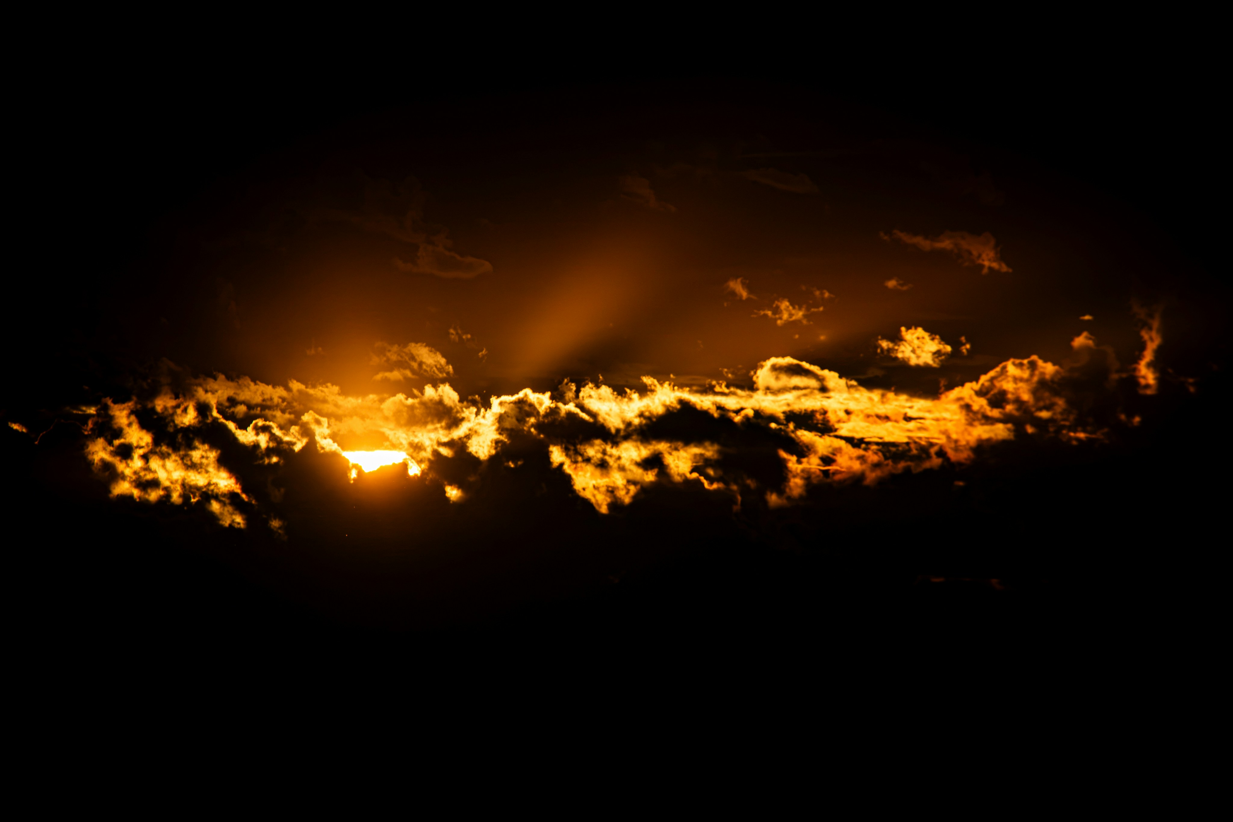 Gilded Horizon: The Sun Pierces a Wary Evening