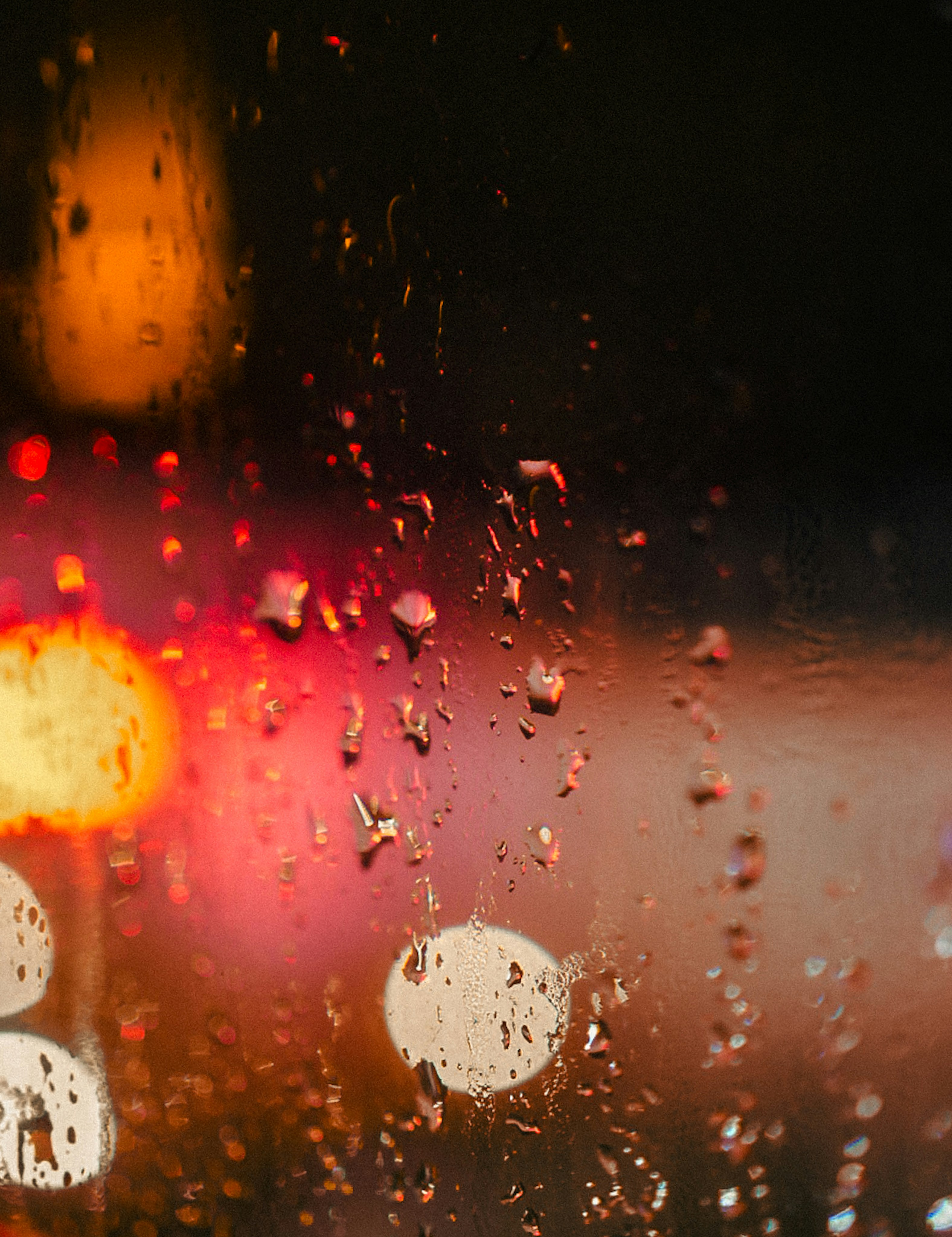 Rain-streaked City Lights Through a Glazed Window