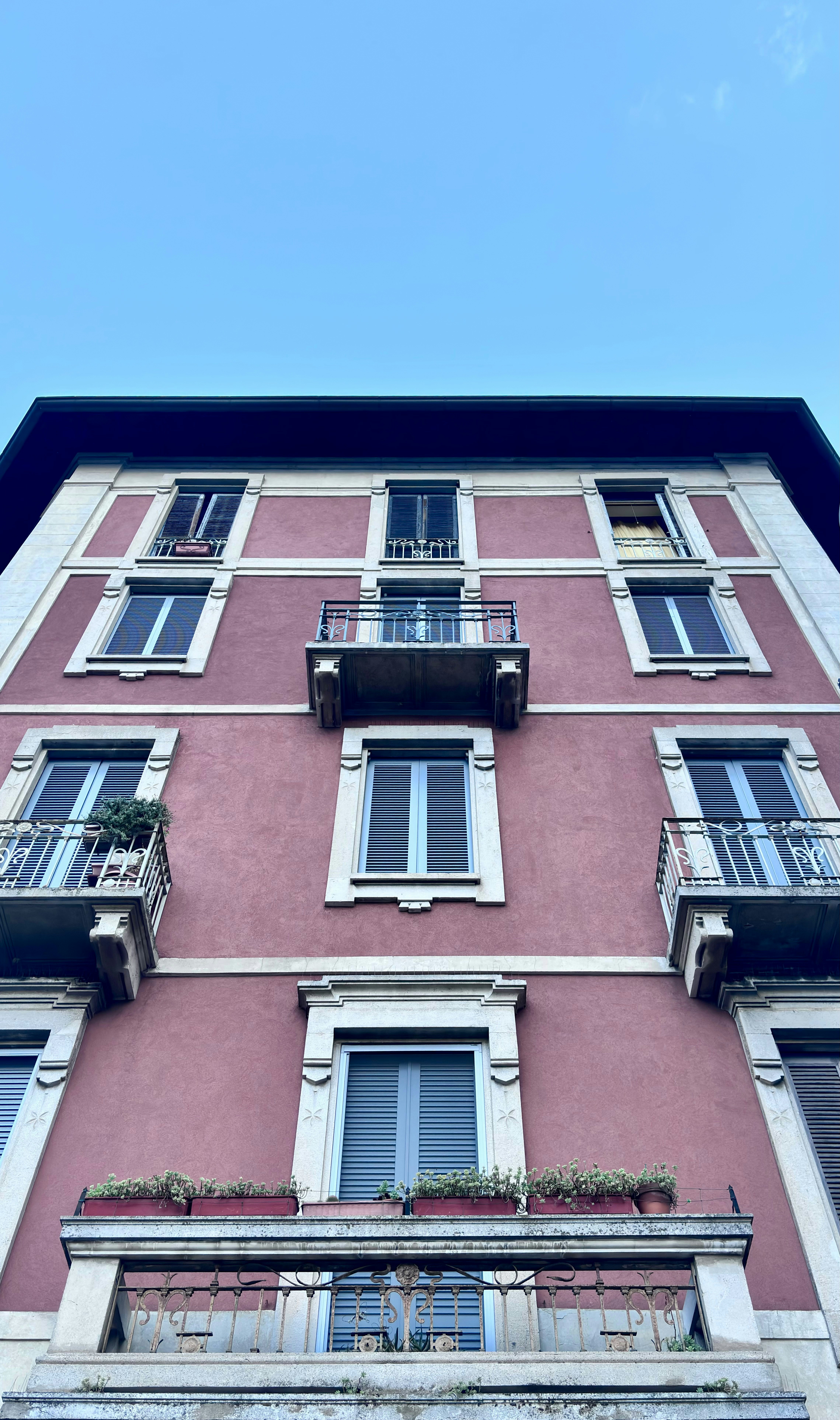 Terracotta Facade Reaching Toward an Open Sky