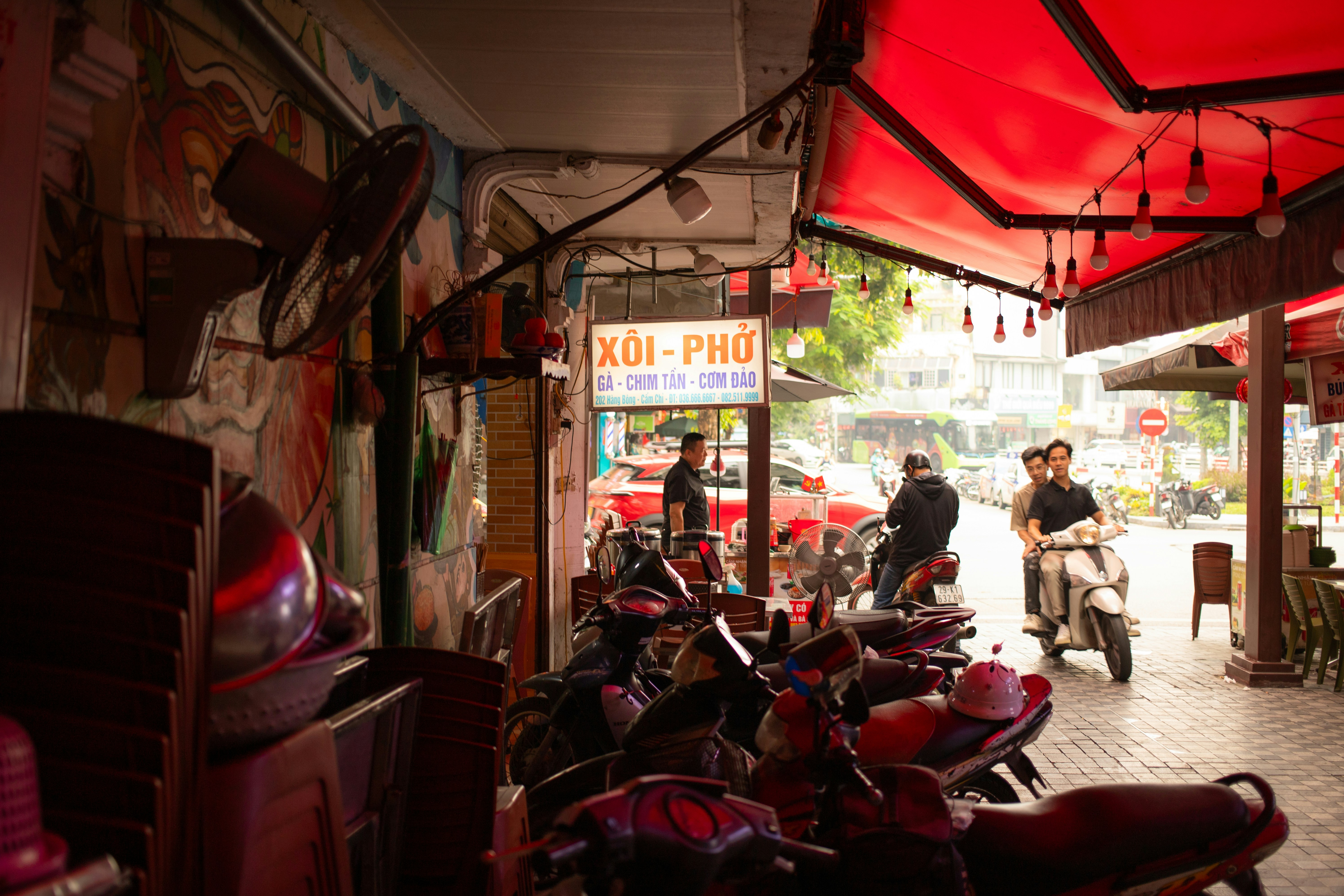 Red Roofs and Neon Signage: A Tiny Street Café Scene
