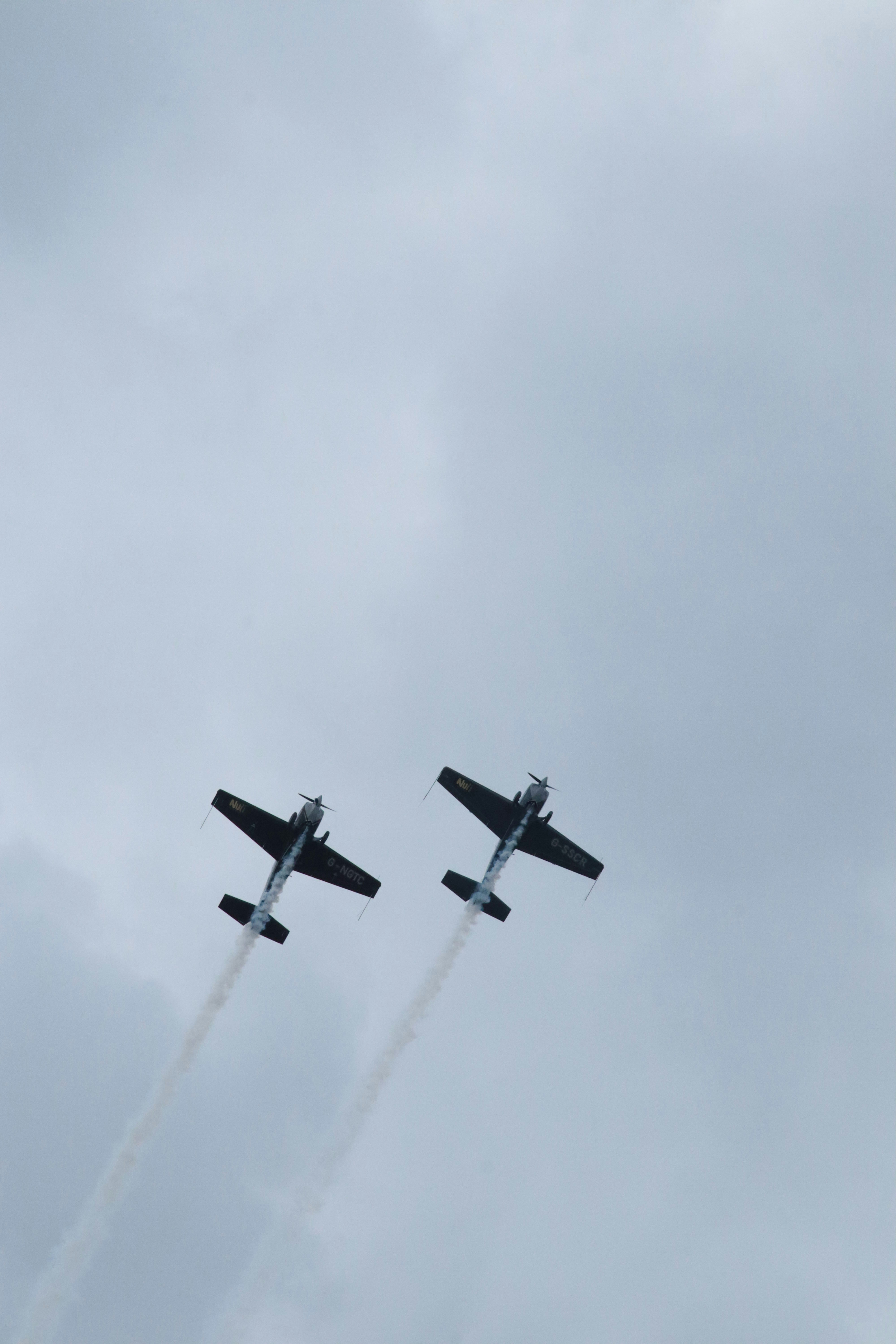Twin Skyward Trails: Acrobatics Above a Quiet Blue