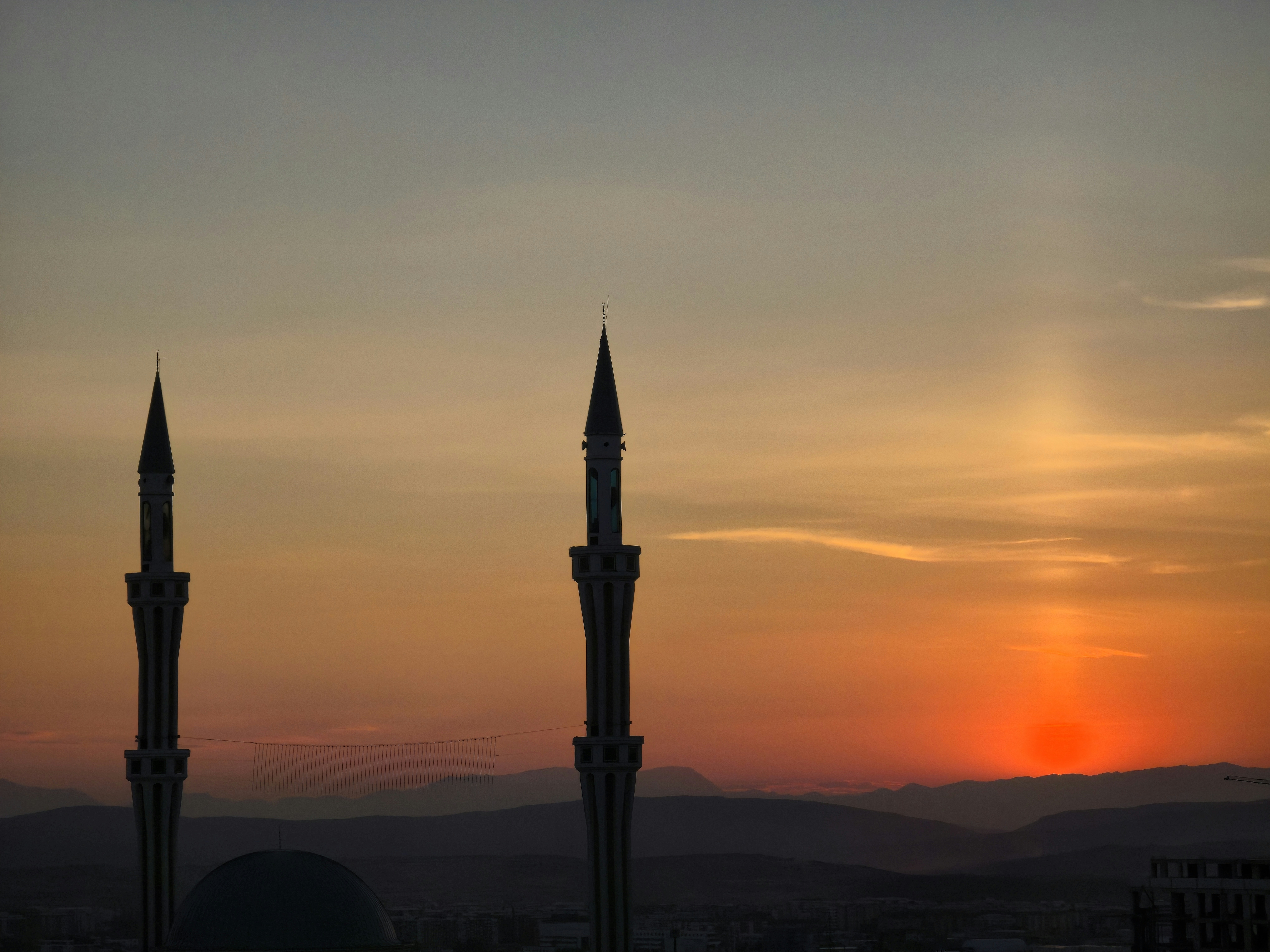 Twin minarets Against a Coral Sunset