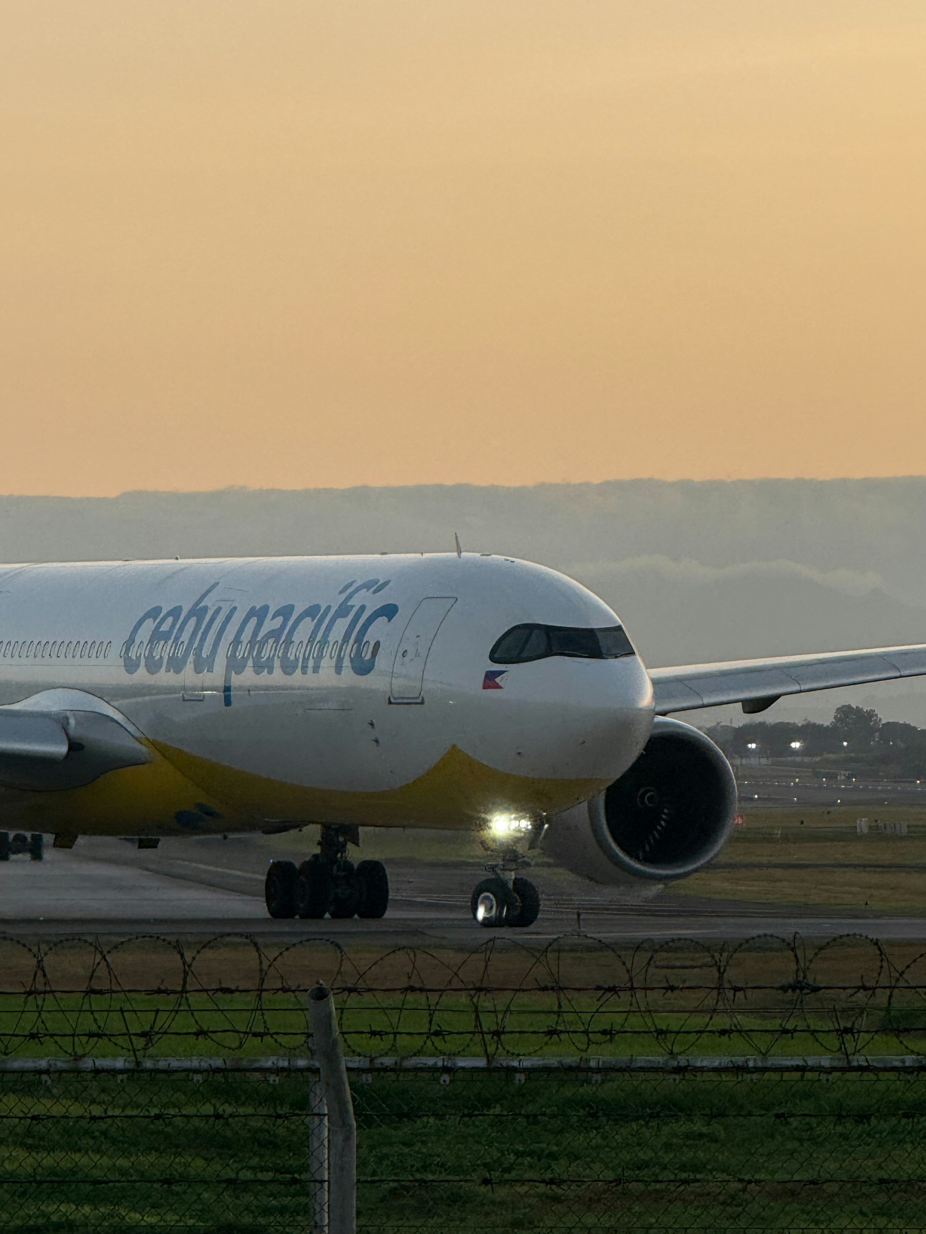 Taxiing Giant: A Cebu Pacific Dreamliner Rumbles Toward the Runway at Sunset