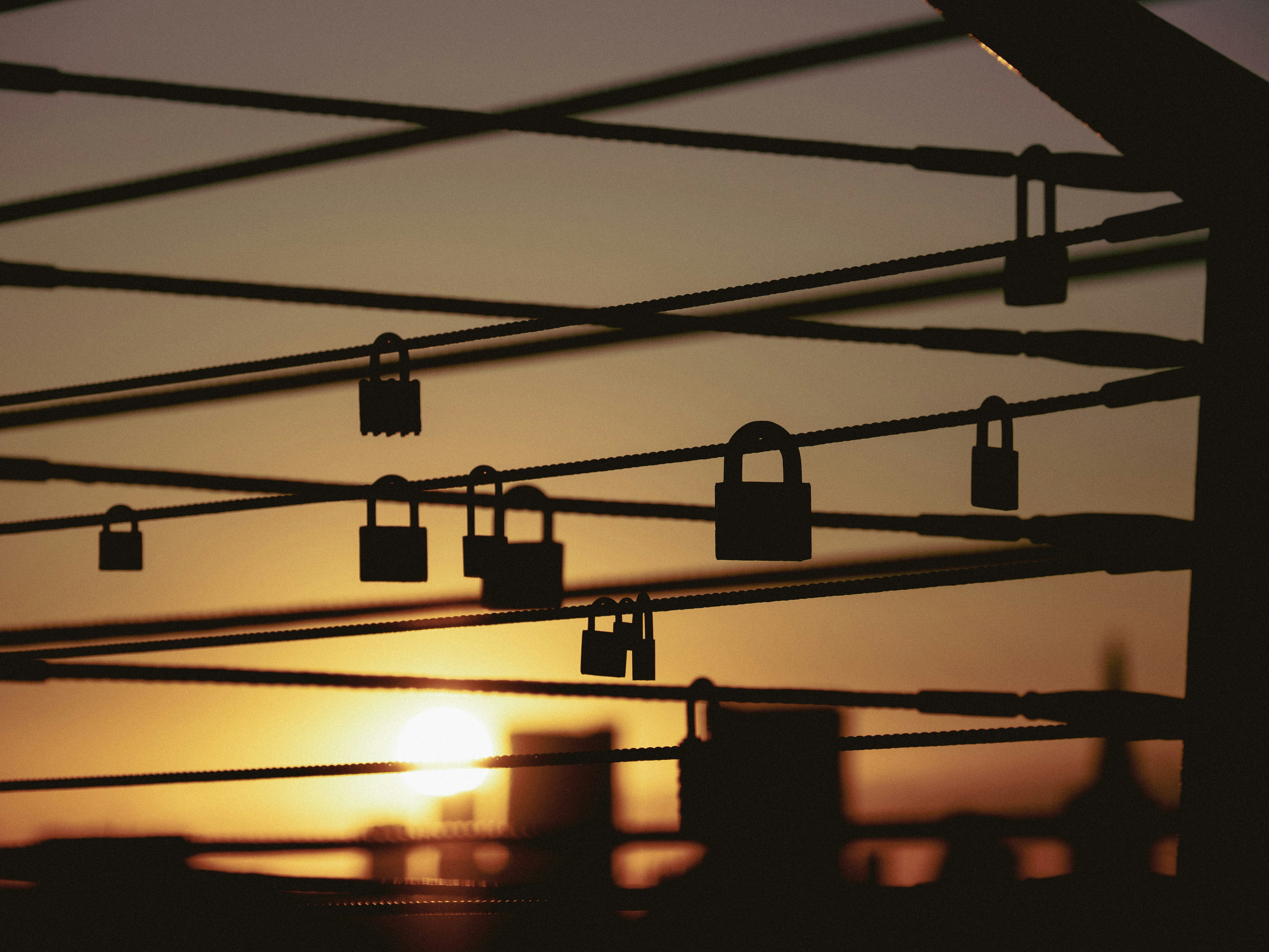 Locks on the Dusk Bridge: A Silhouette of Hope