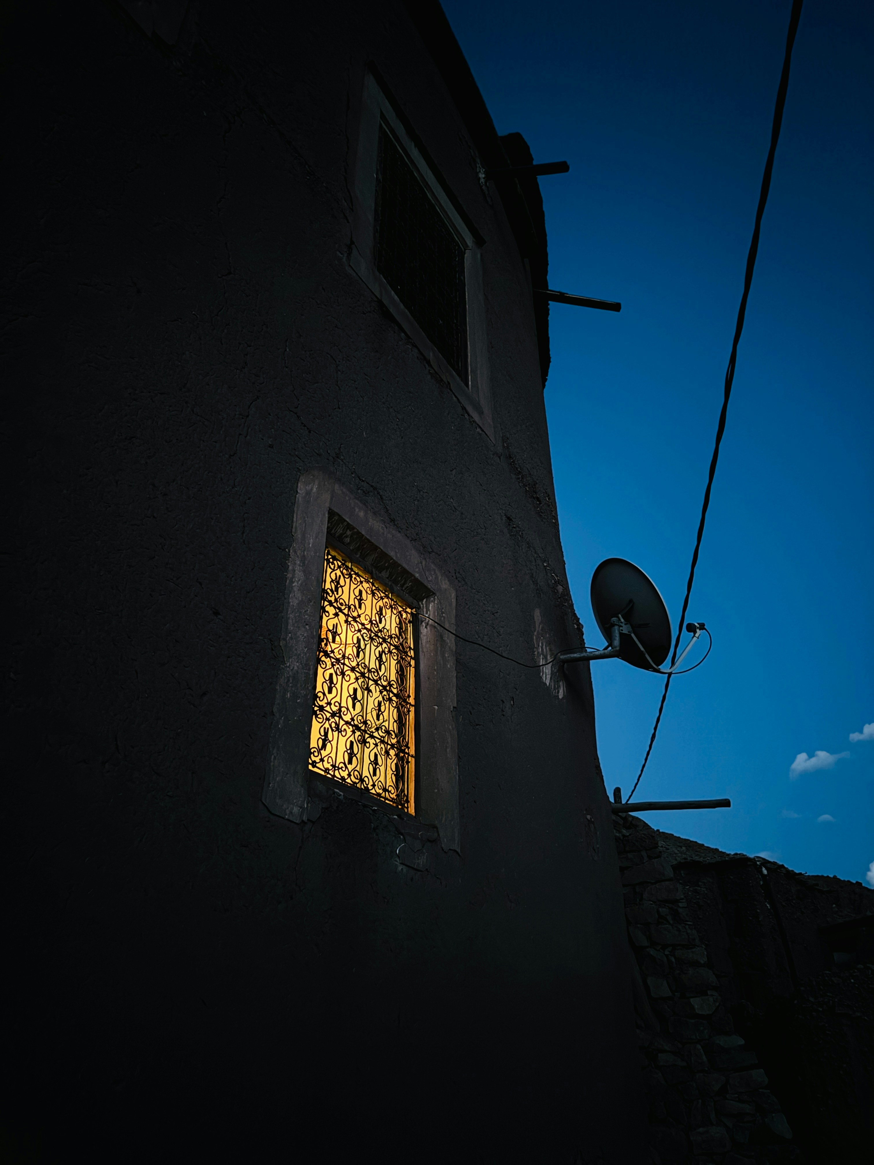 Glowing Window in a Midnight Courtyard