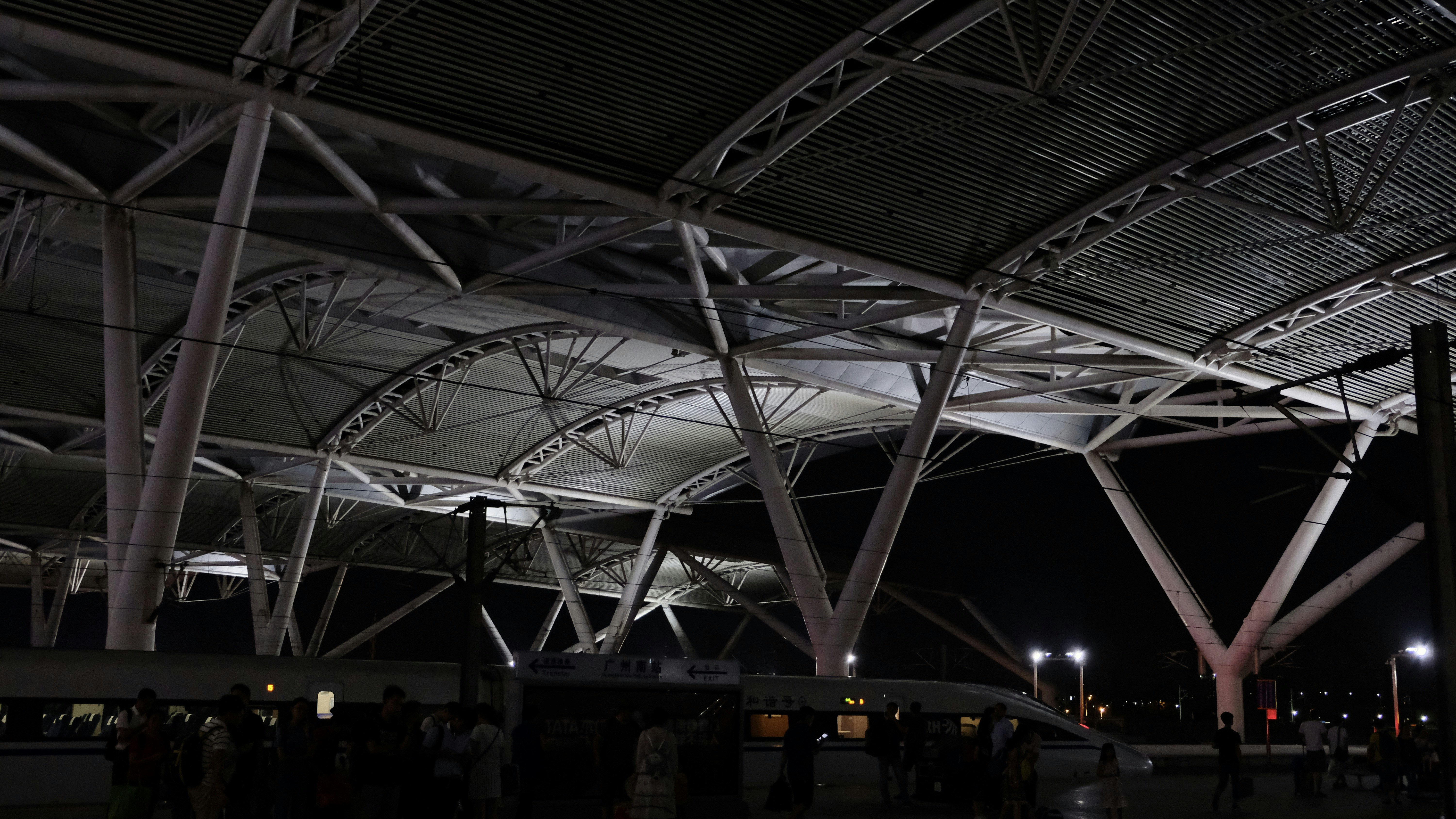 Neon Geometry Under Night Steel: A Stadium Roof in Motion
