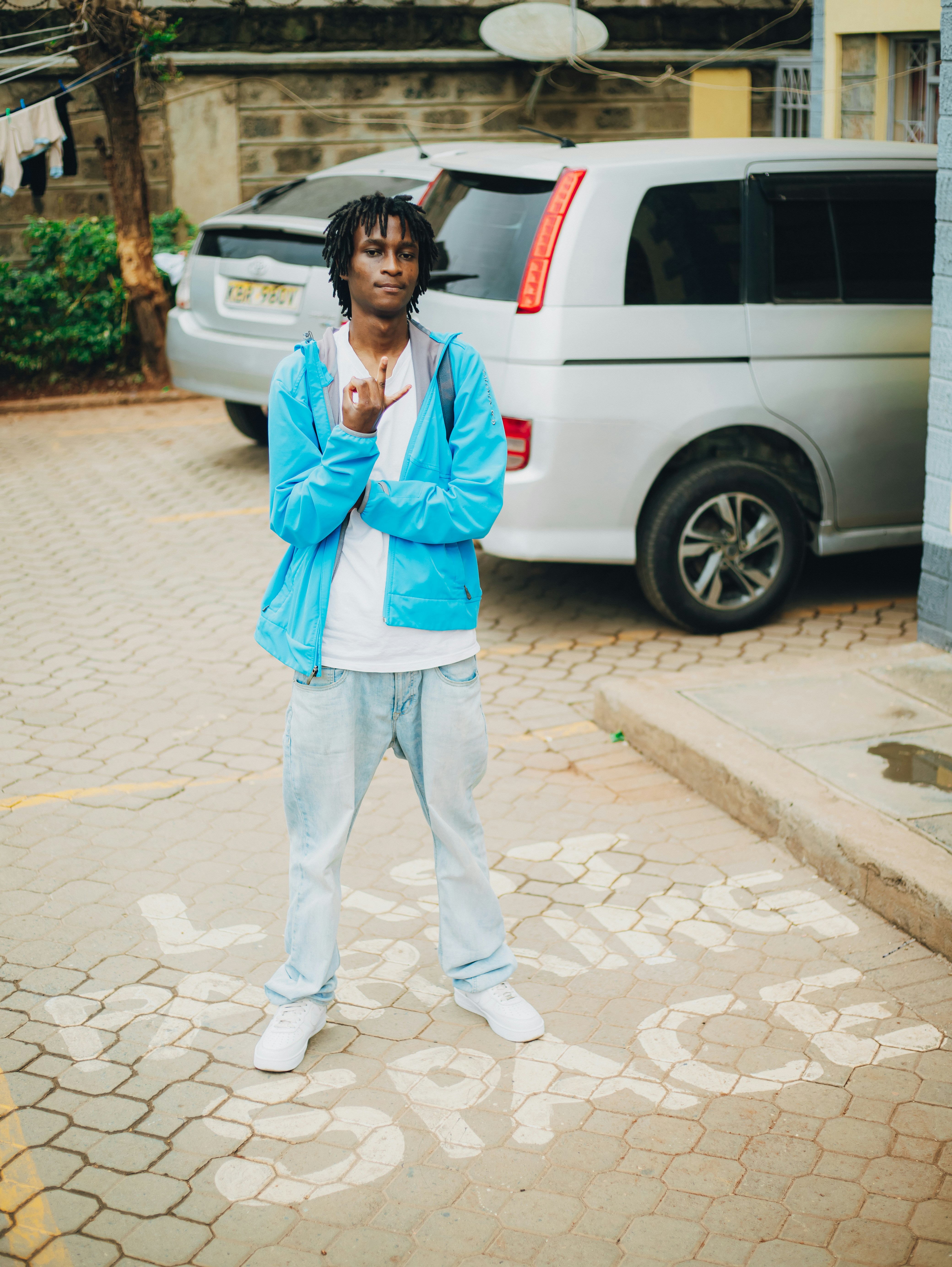 Blue-Jacket Stance in a Quiet Parking Lot