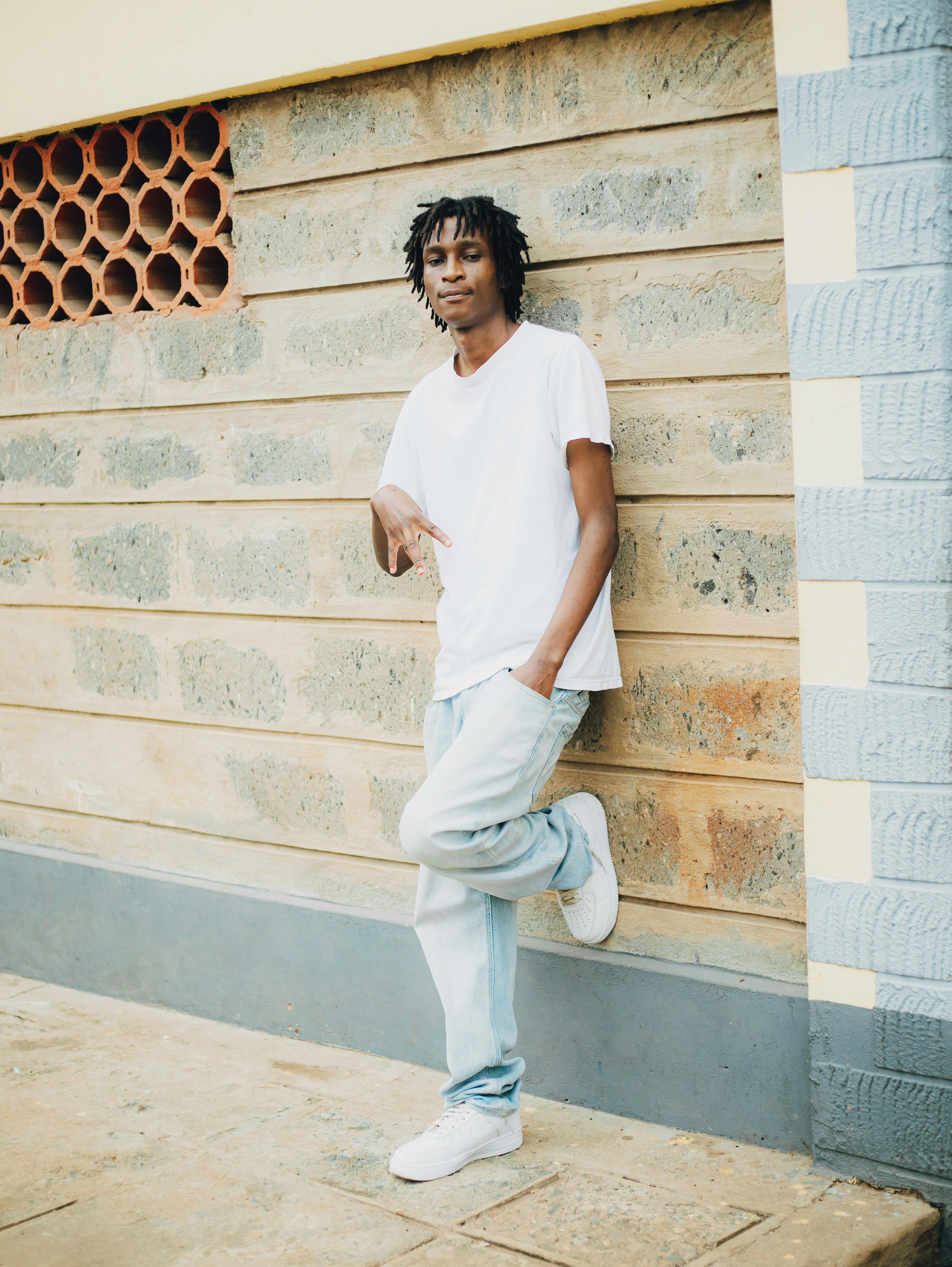 Portrait of Confidence: A Youth Leaning Against a Concrete Wall