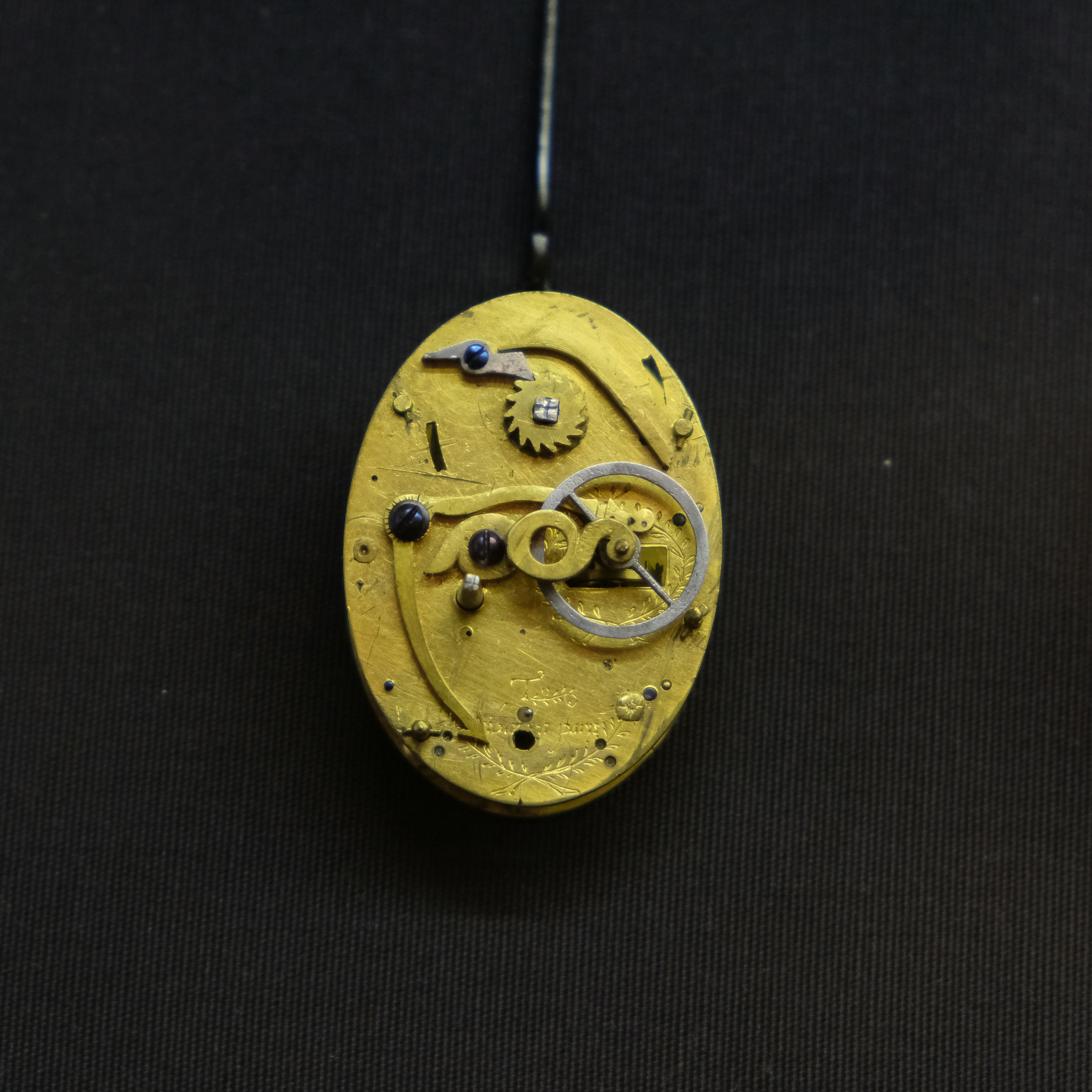 Gilded Clockwork Heart: A Lone Watch Mechanism in Focus