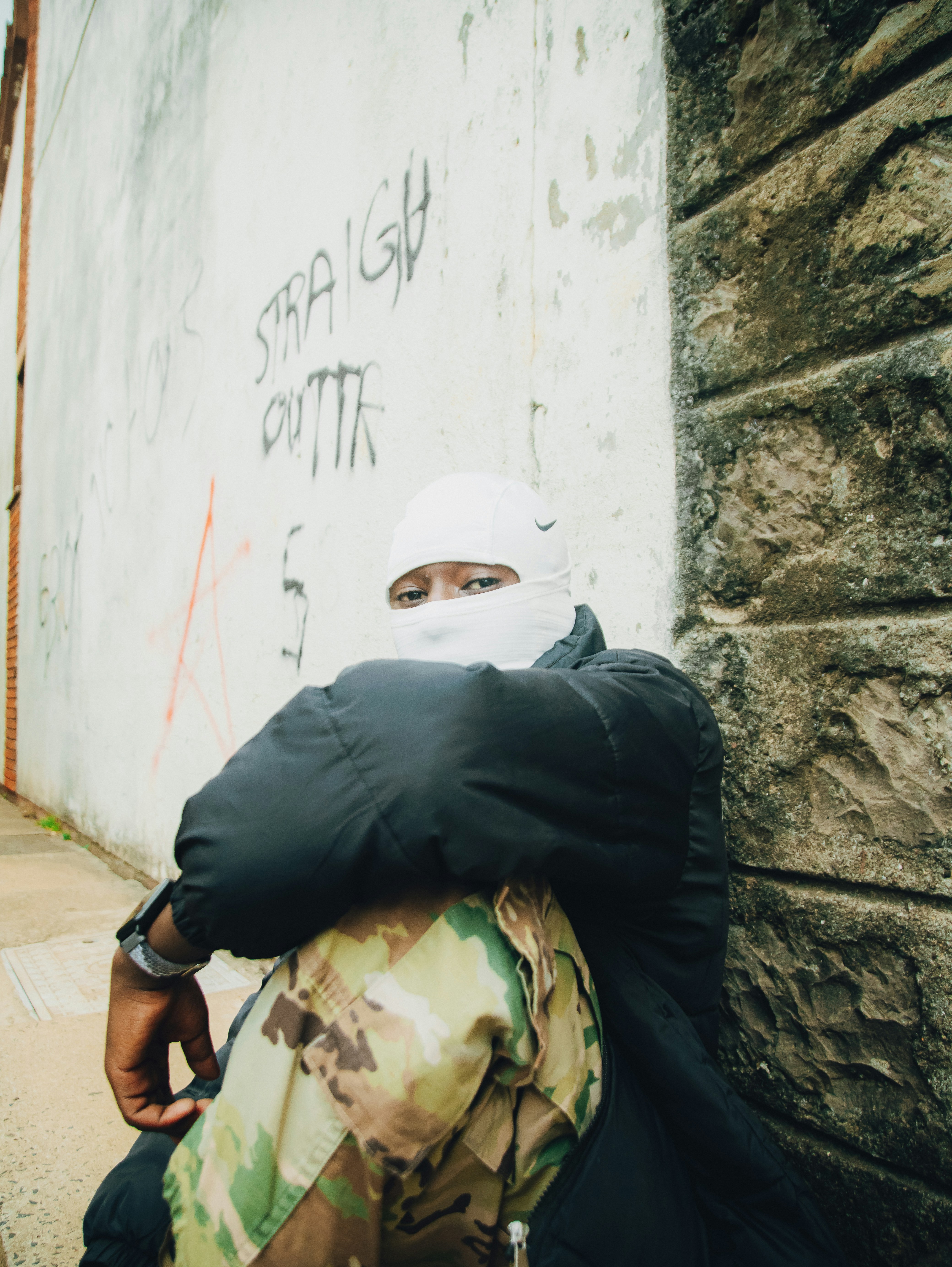 Masked Messenger: Quiet Intensity in an Urban Alley