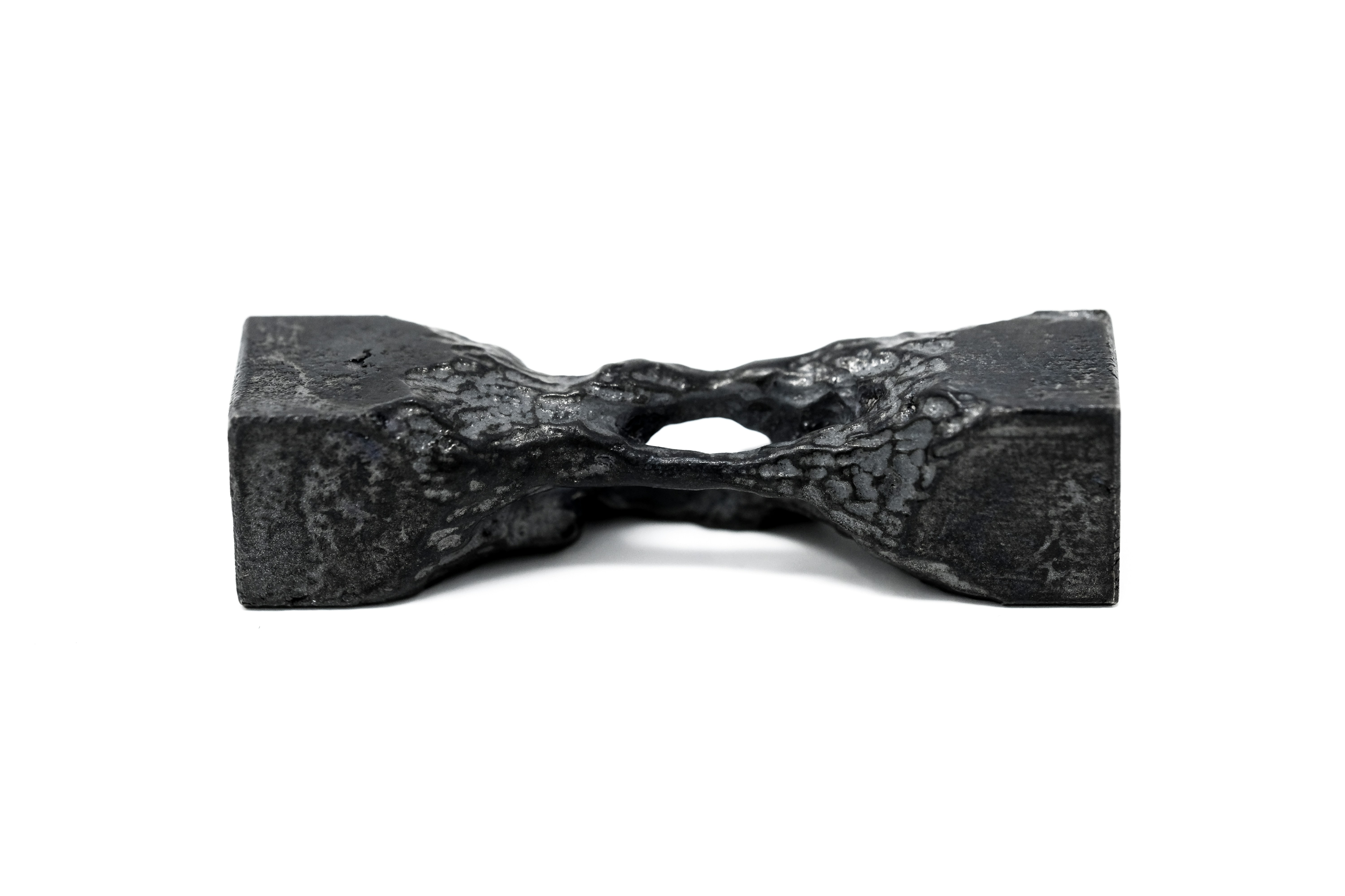 Pinned Midnight: a charred iron spacer frozen in stillness