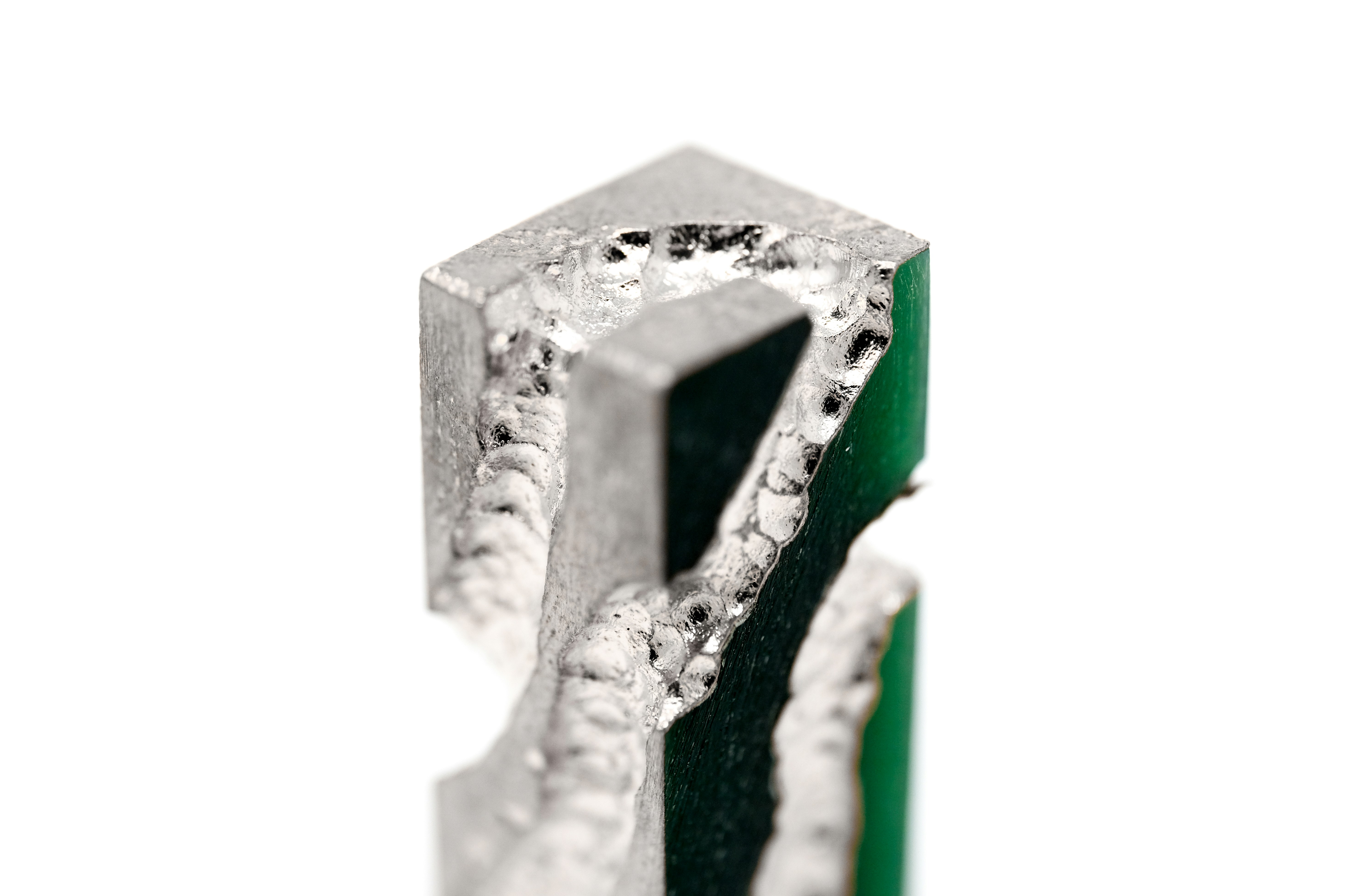 Macro Fragment: A Fractured Metal Edge in Harsh White Space