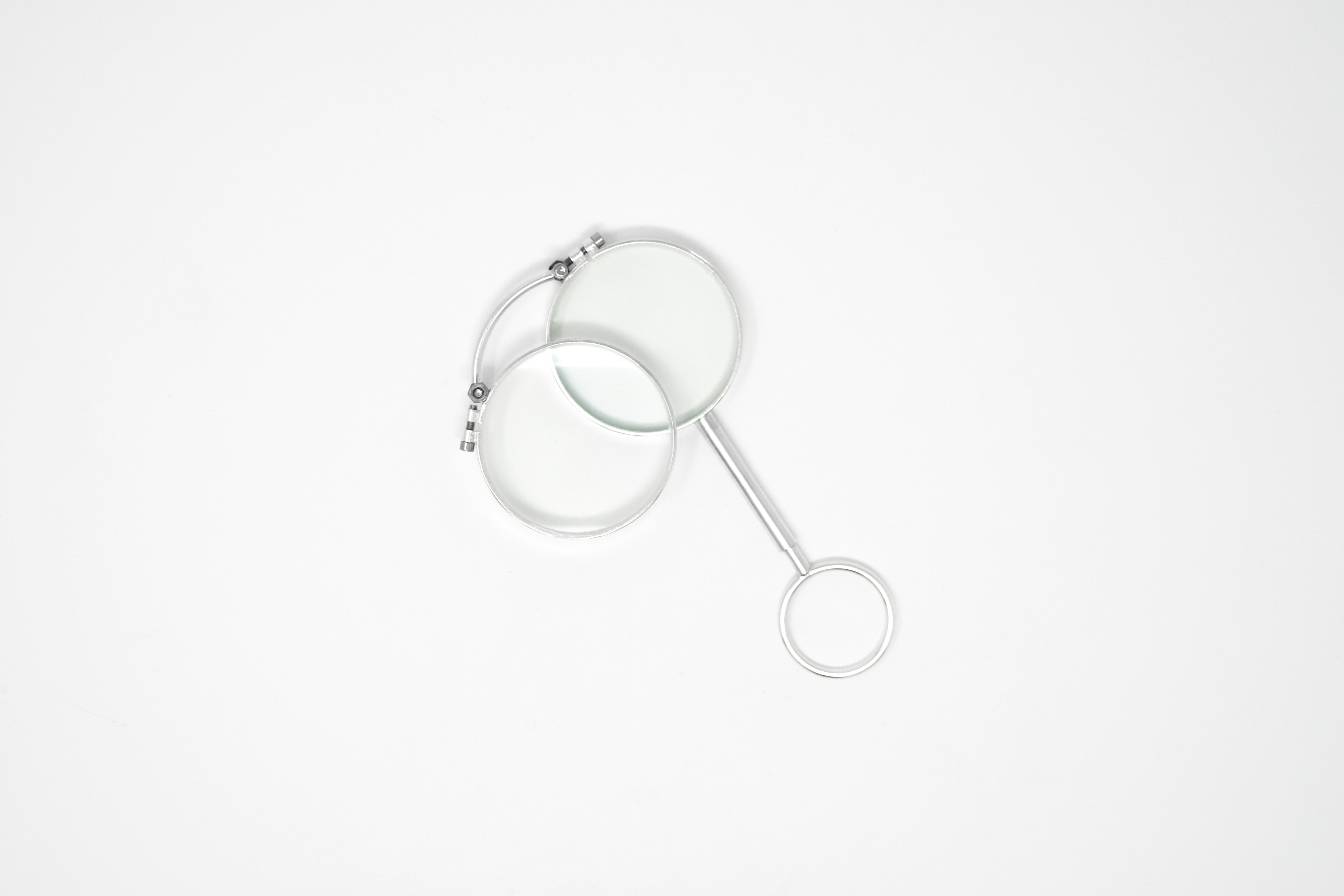 Minimalist Key: A Pair of Silver Handcuffs on Endless White