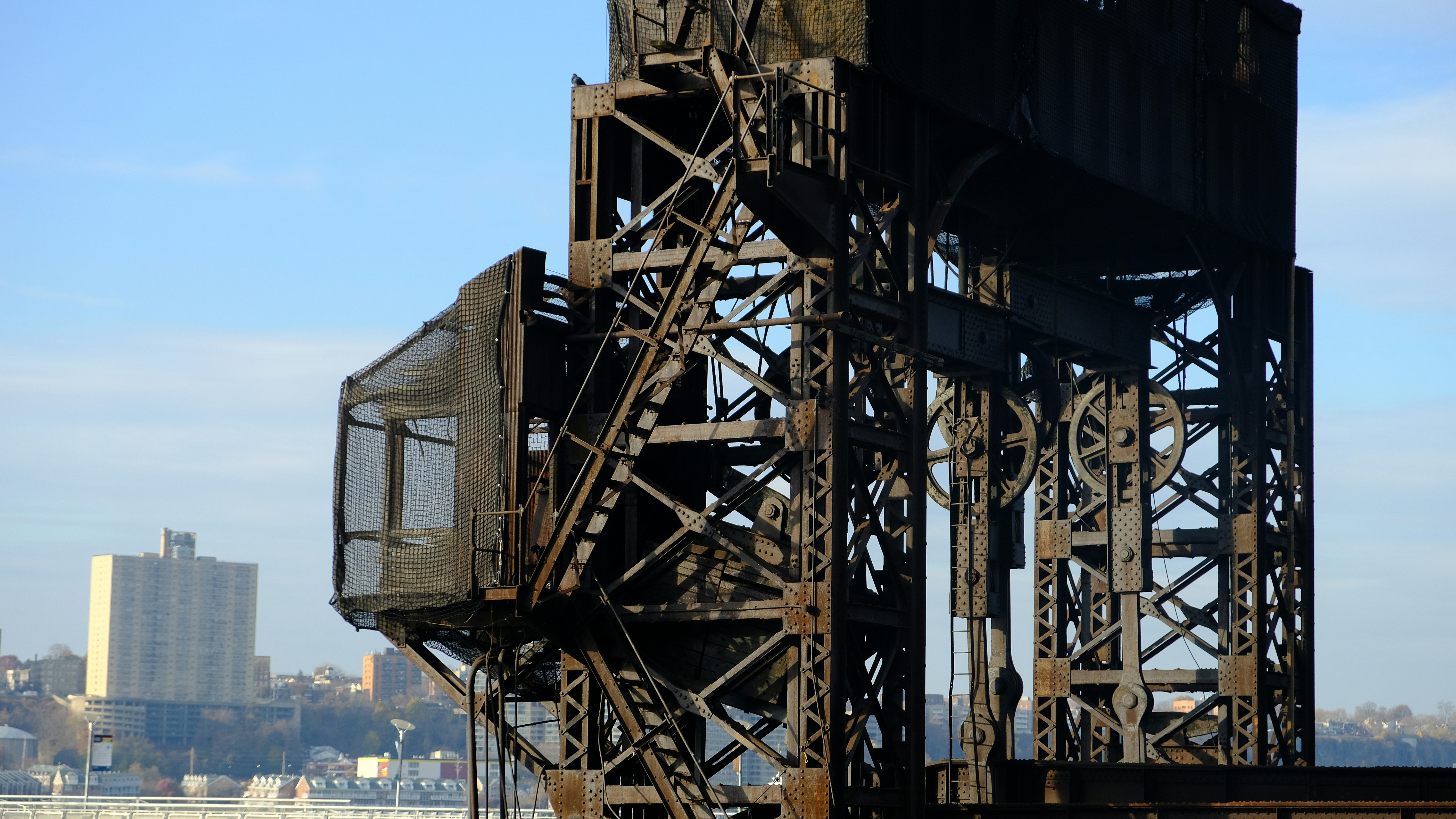 Rusted industrial silhouette against a distant cityscape