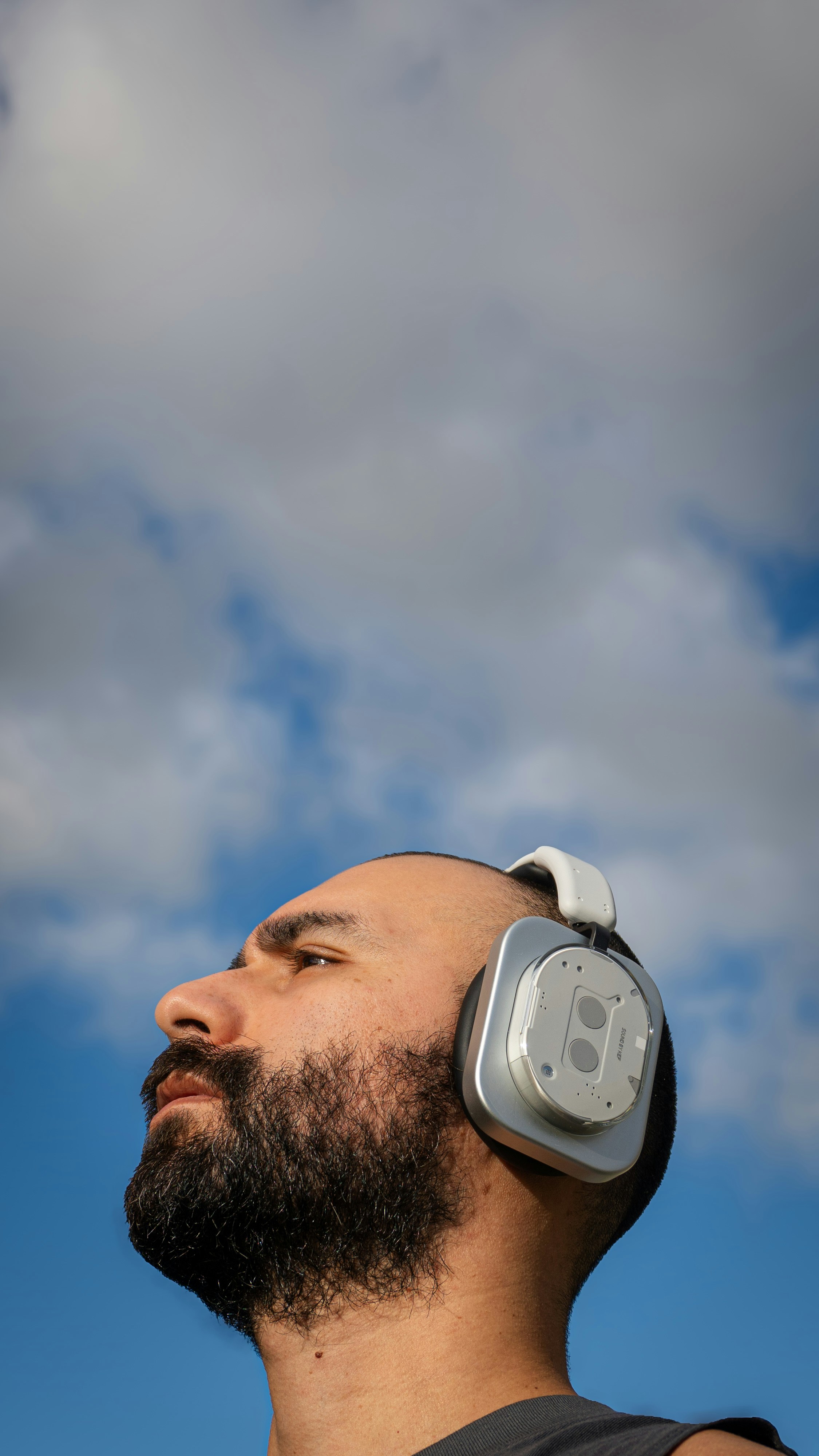 Overhead Quiet: A Headset Halo Against a Bright Sky