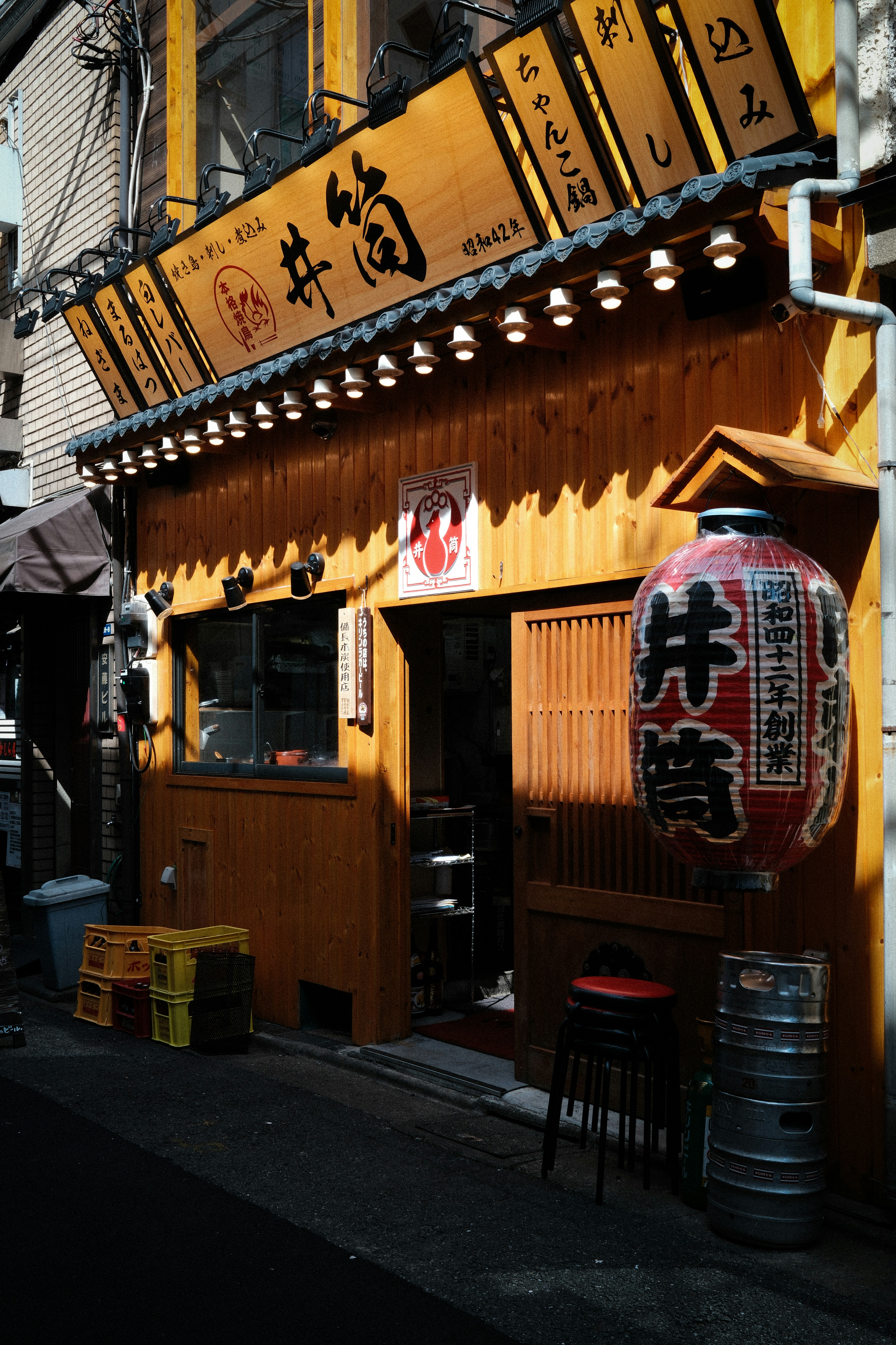 Lantern-lit Entrance: Warm Wood, Narrow Street, and a Red Lantern