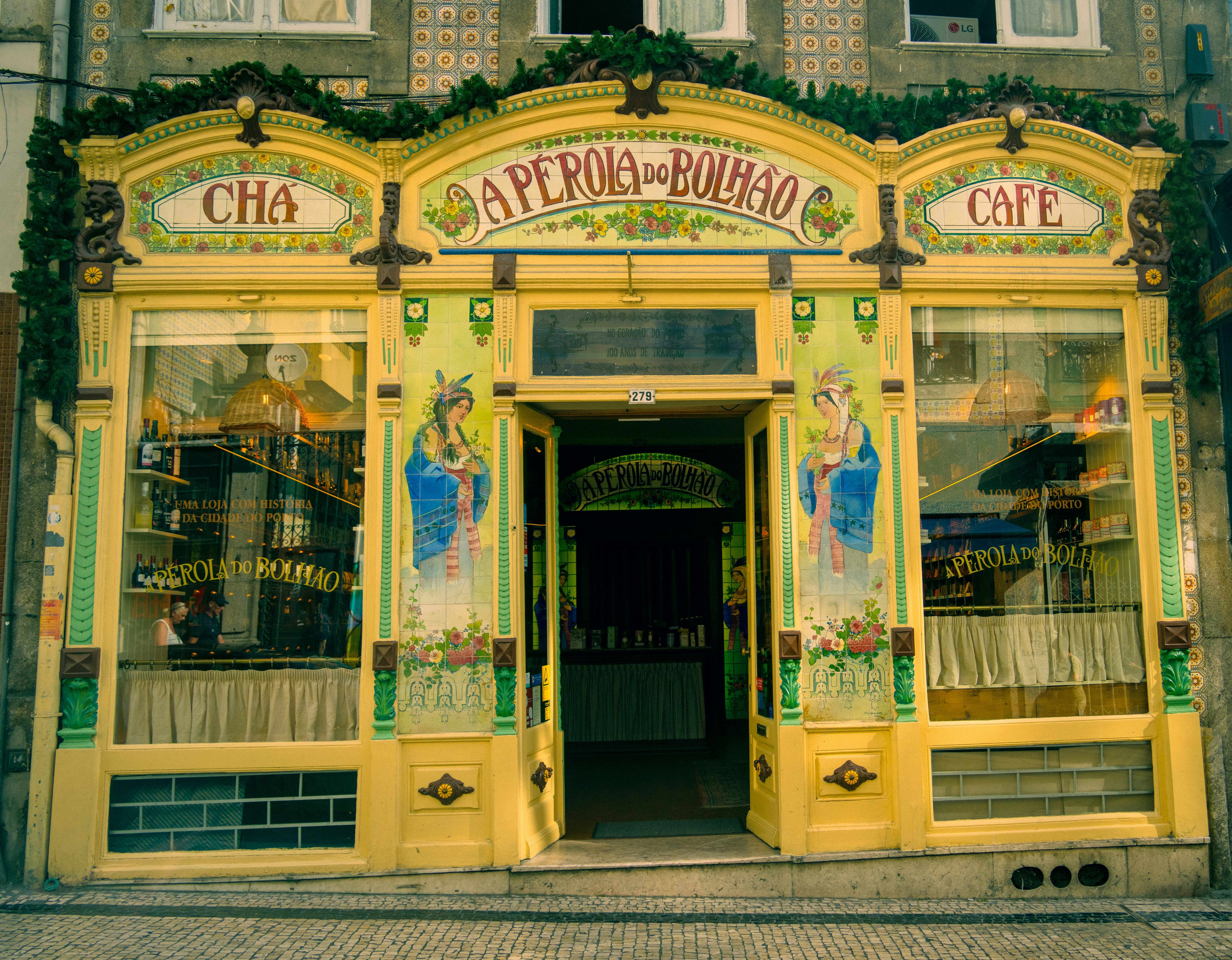 Ornate Lisbon Café Awning: A Burst of Tile and Yellow Facades