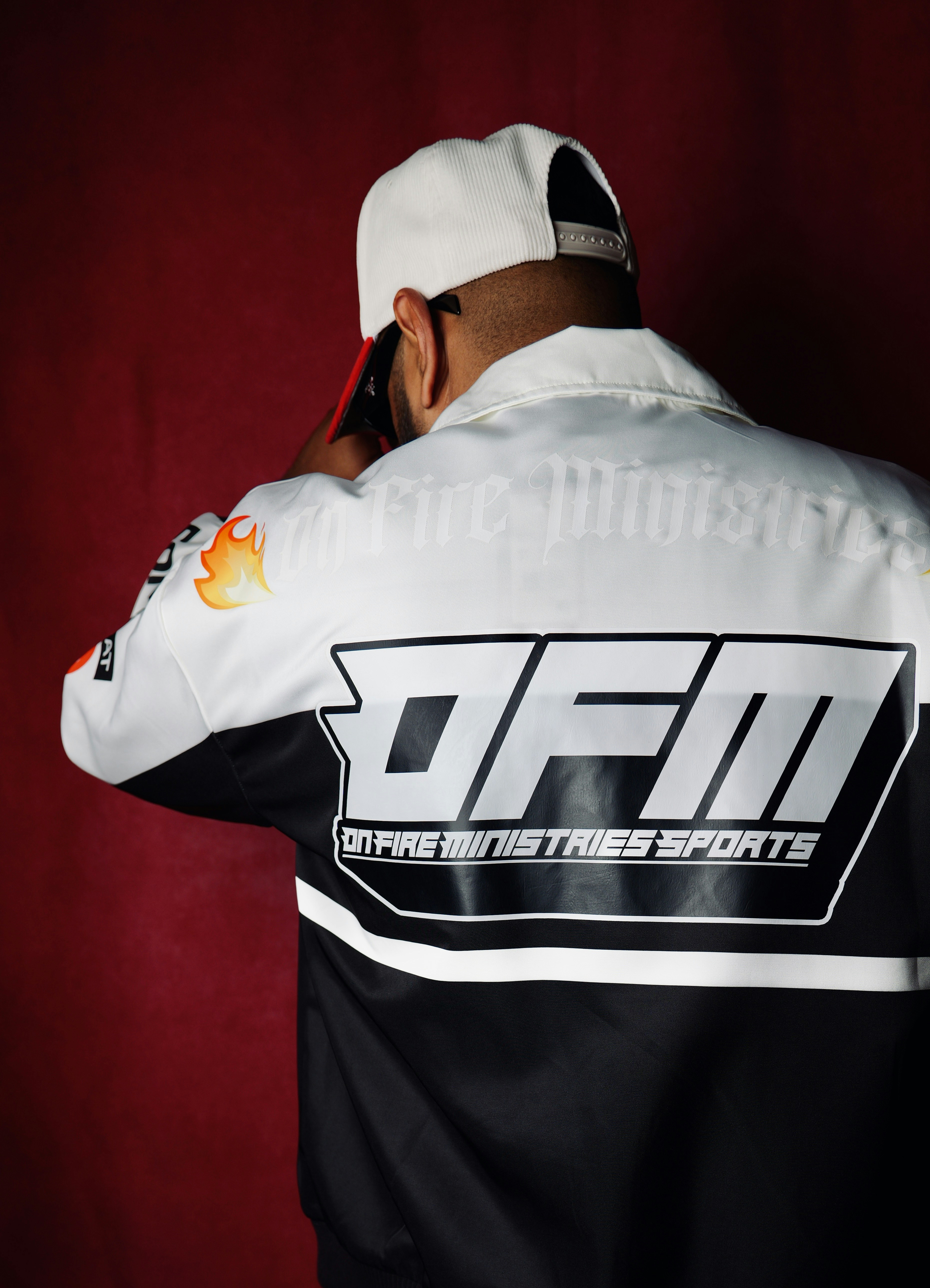 Back View of a Sportswear Enthusiast: Bold Logo Prominence Against Crimson Backdrop