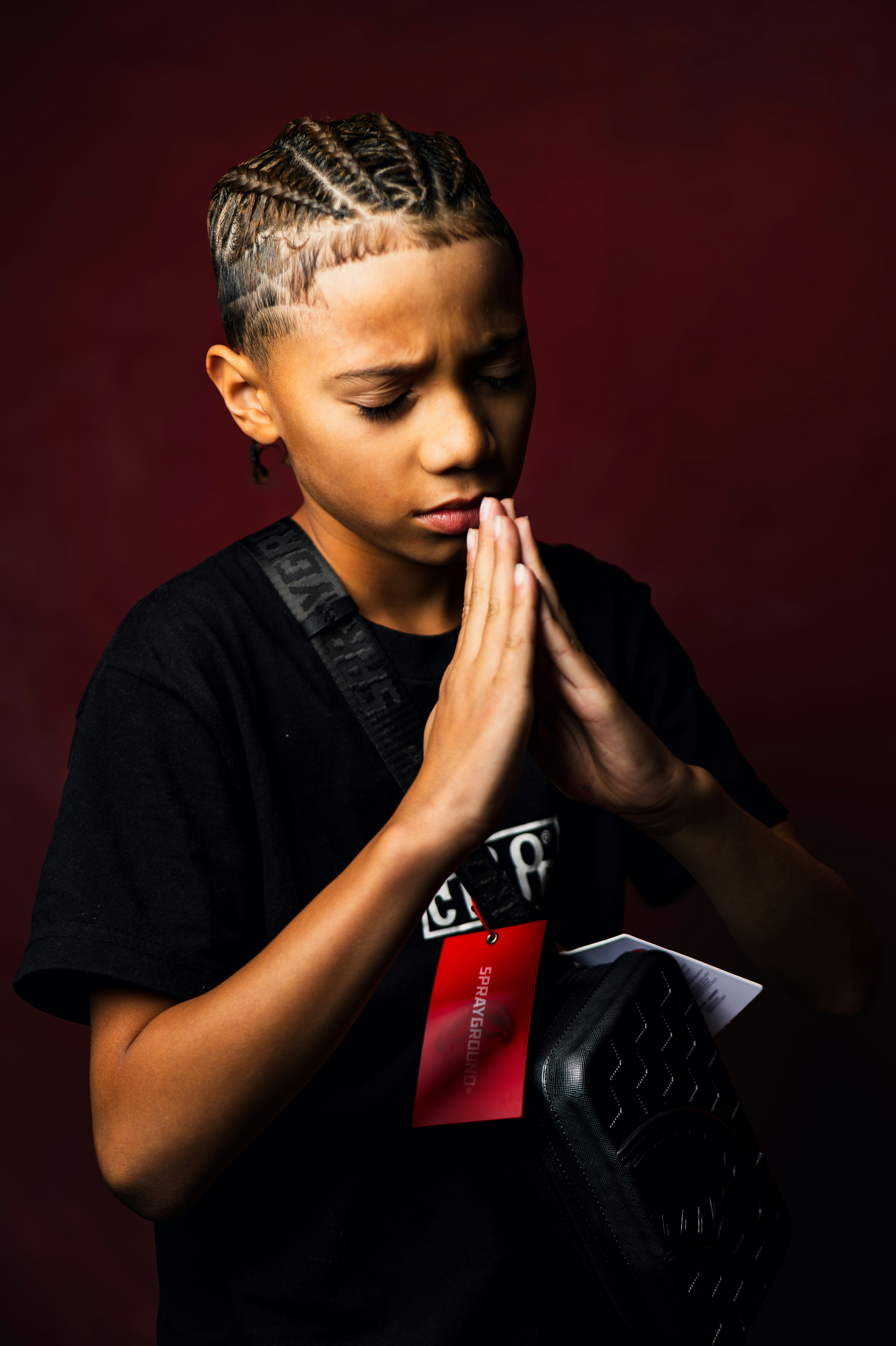 Prayerful Focus: Quiet Intention in a Portrait of a Young Praying Hands