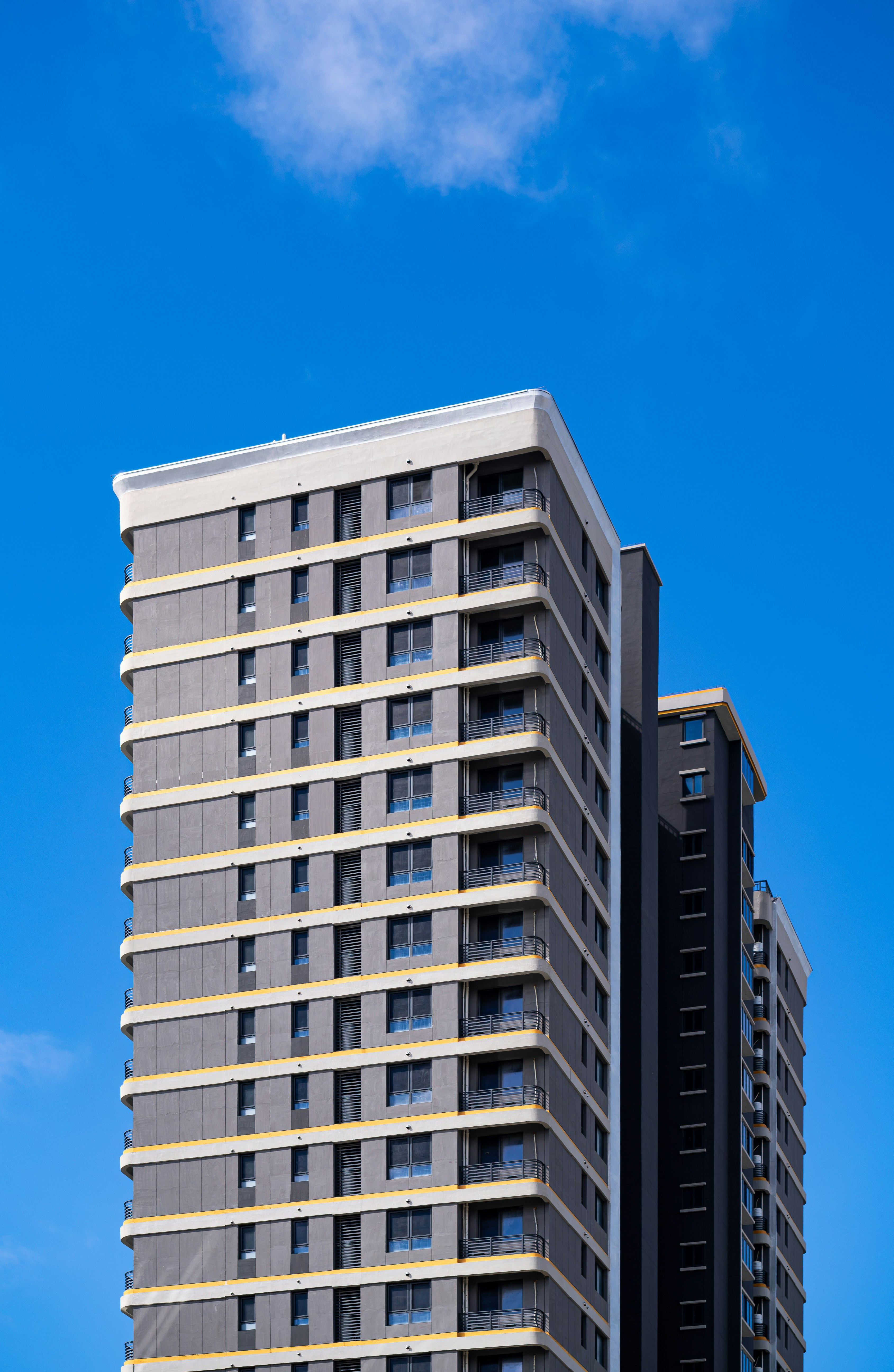 Vertical Geometry: A Towering Facade Reaching Toward a Clear Sky