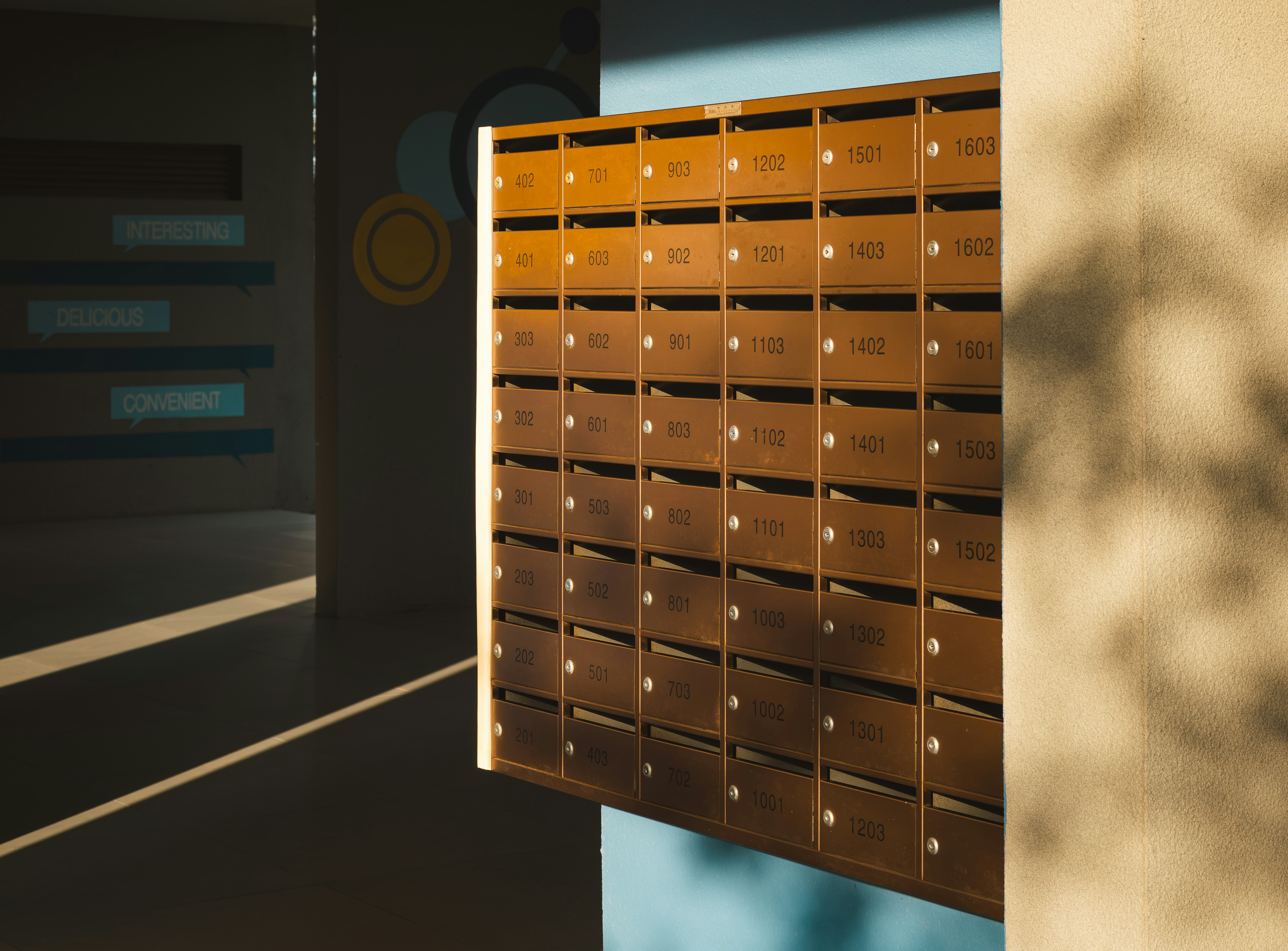 Sunlit Mailbox Corridor where Geometric Doors Meet Shadowed Hall