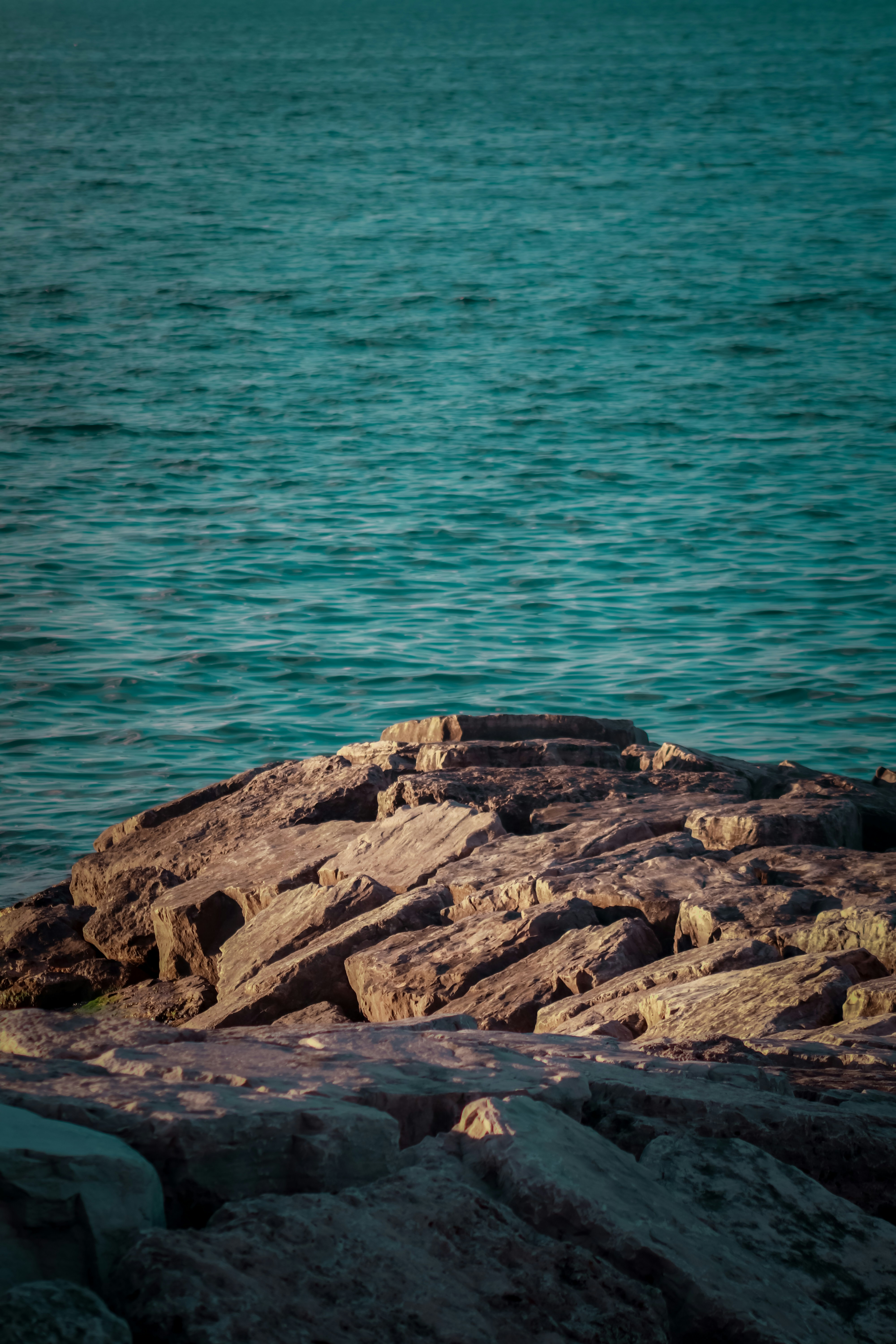 Rugged shoreline meeting a calm turquoise horizon