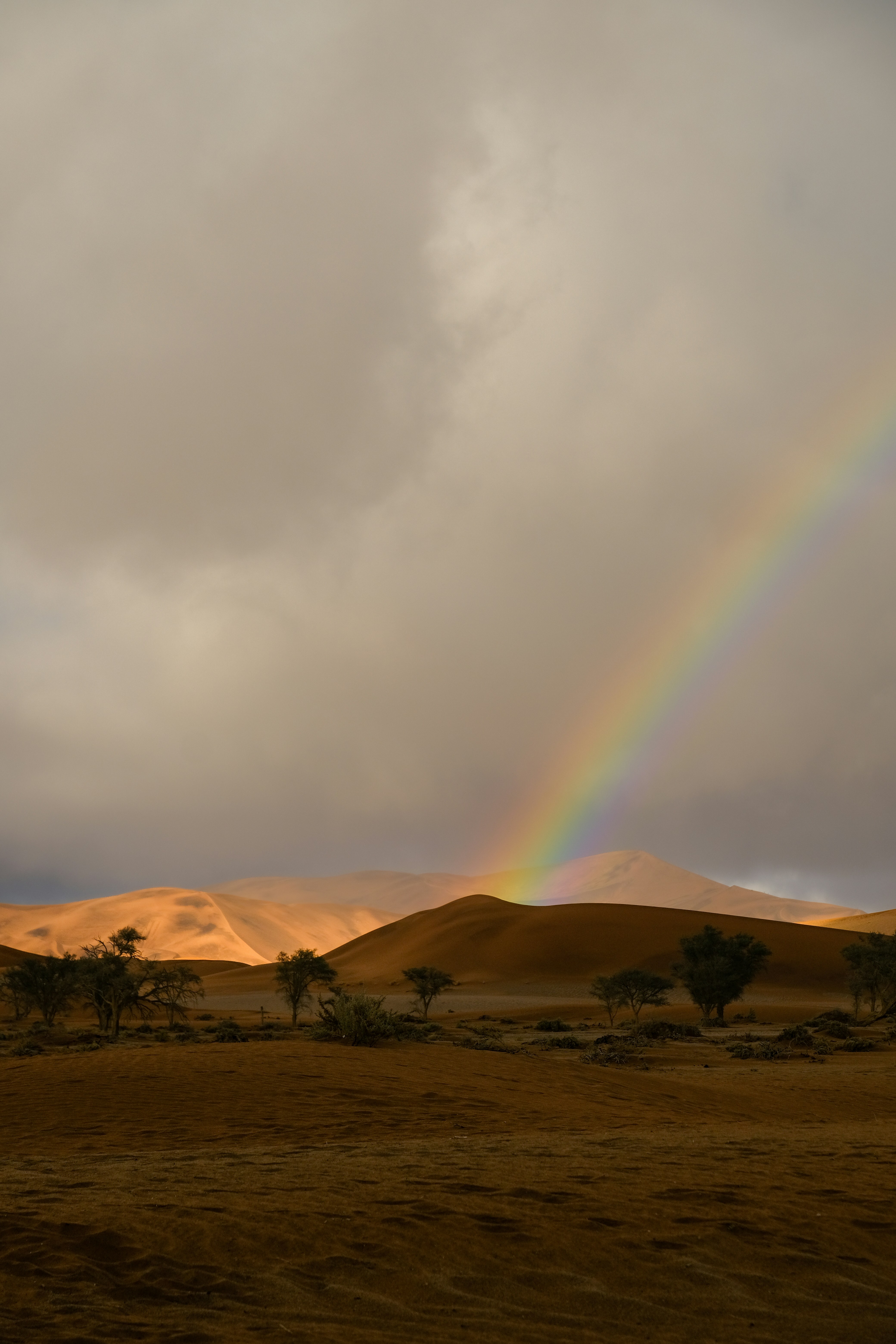 Rainbow over Desert Dunes at Dusk