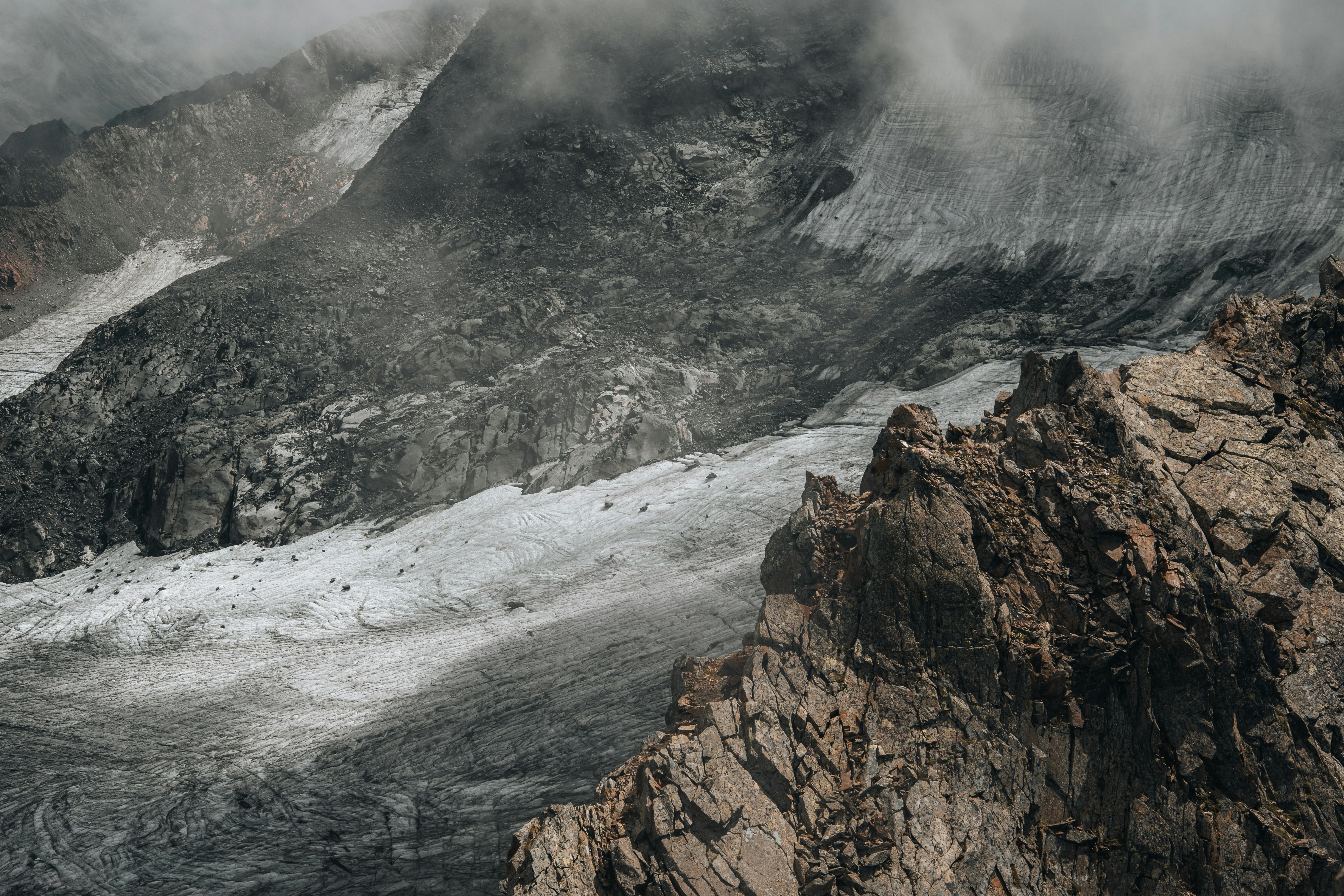 Rugged Alpine Verge: Snowfield Meet Stone