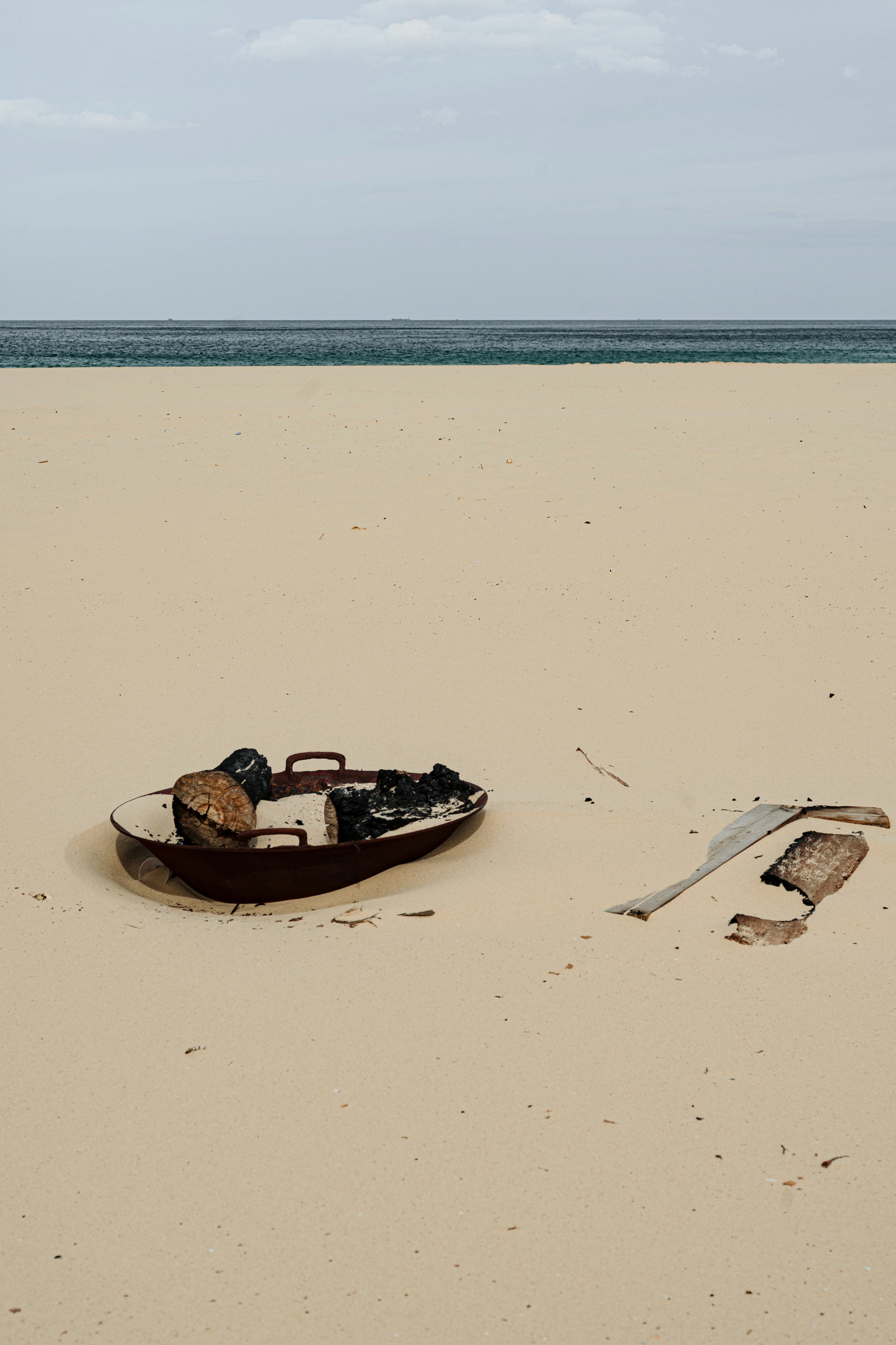 Charcoal Grill on Desolate Beach at Dusk