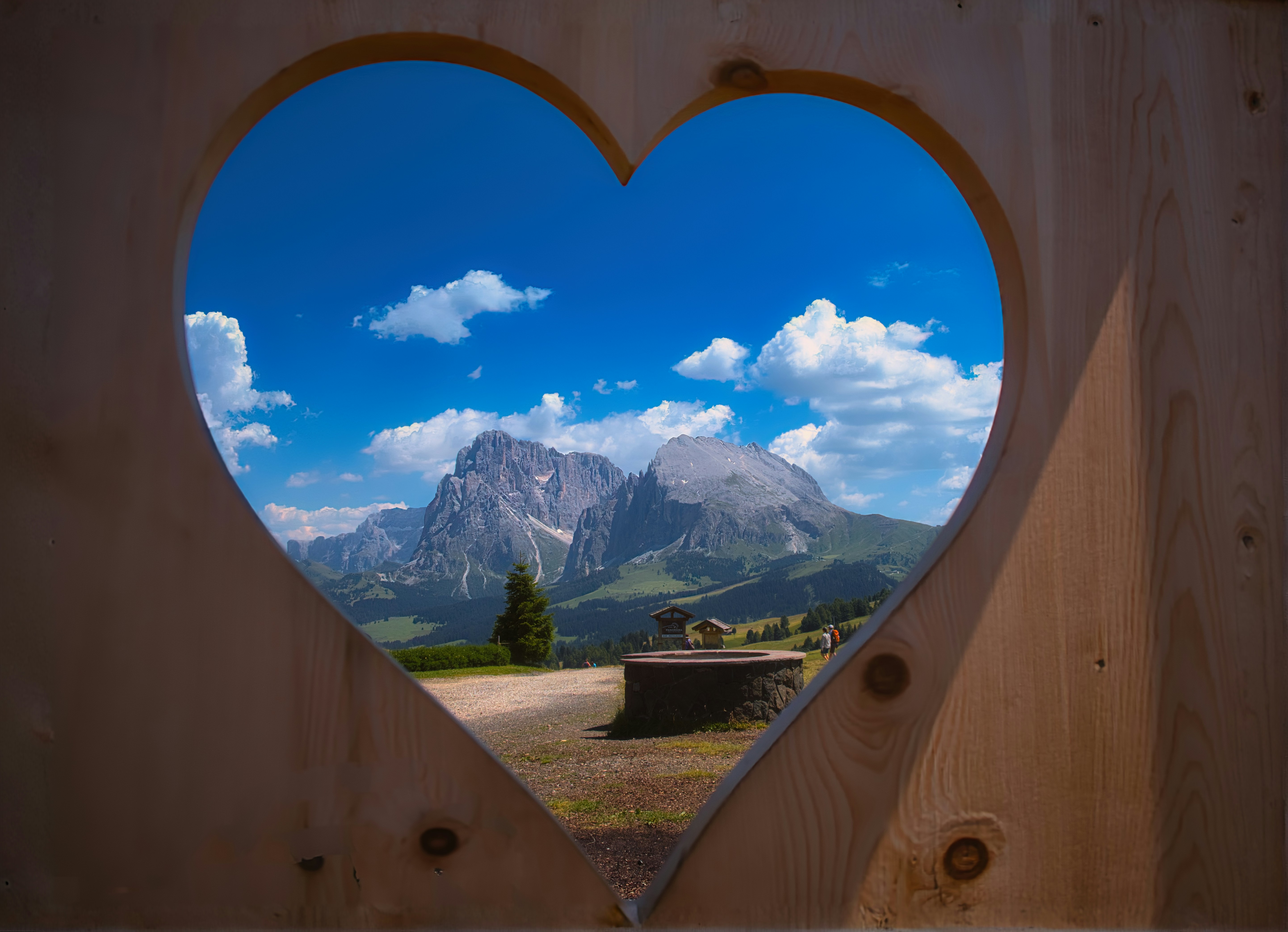 Heart of the Valley: Framed Mountain Vista Through a Wooden Heart