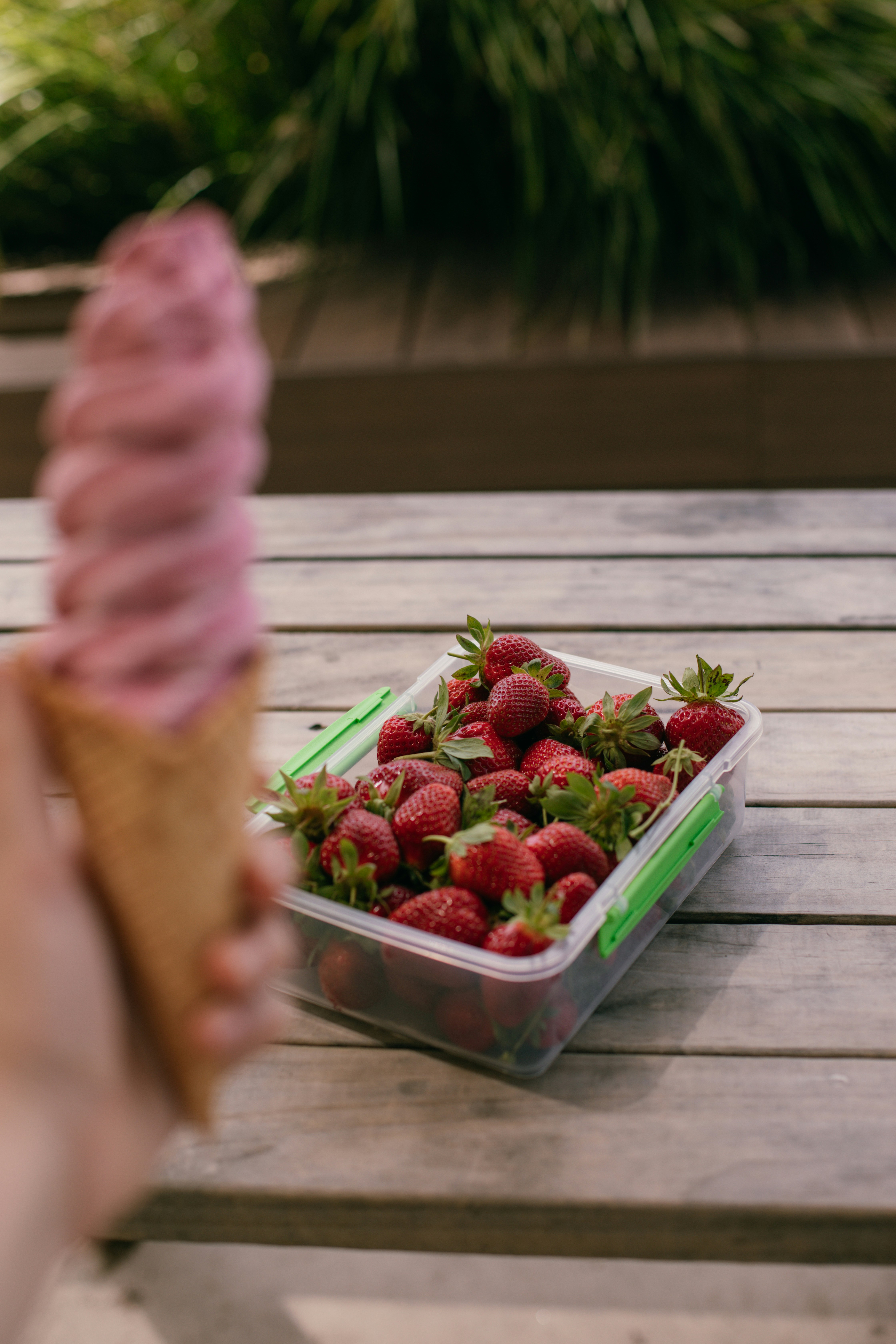 Strawberry Harvest on a Wooden Table with a Strawberry Cone