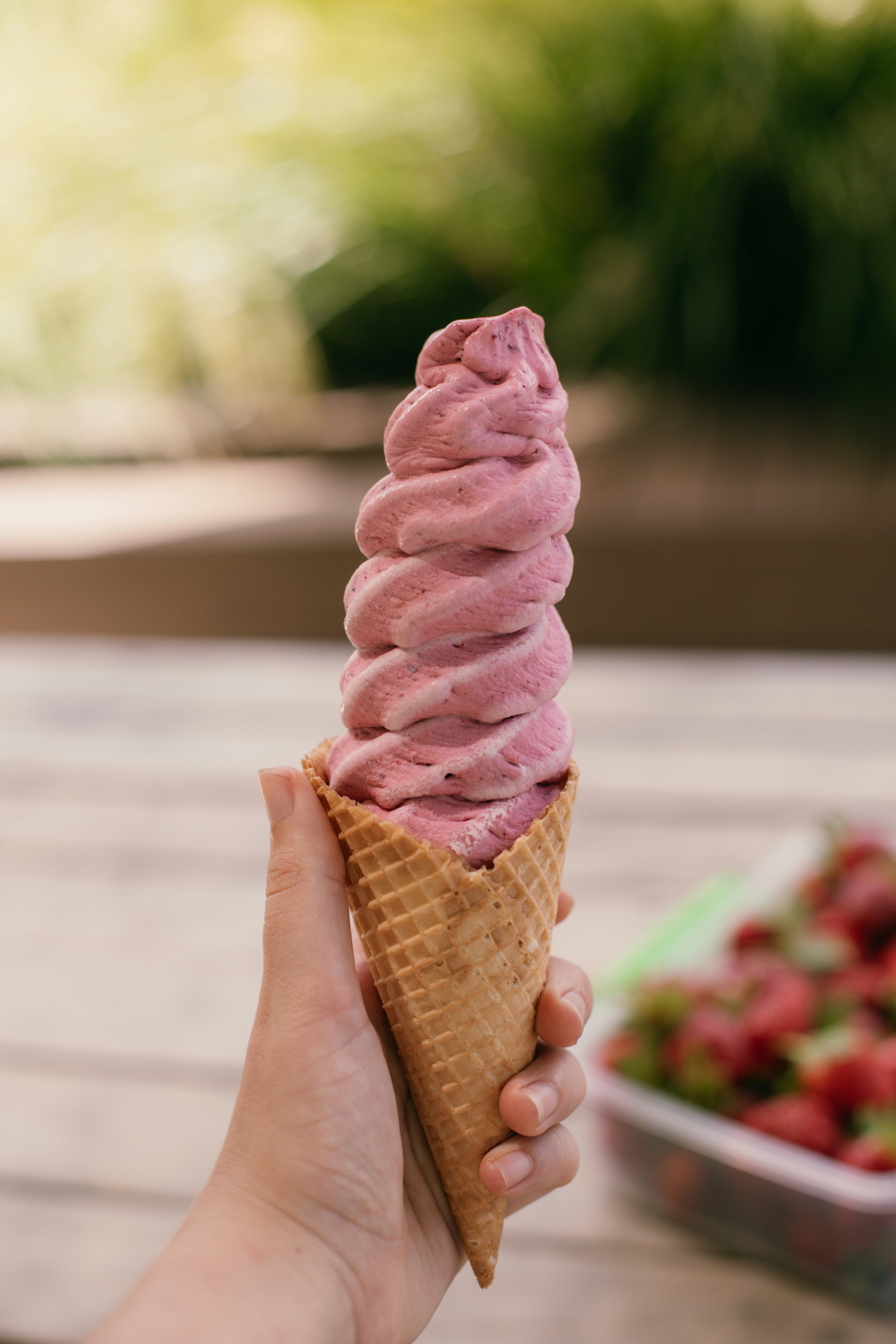 Twist of Berry: A Pink Twist Cone Gripped in Focus