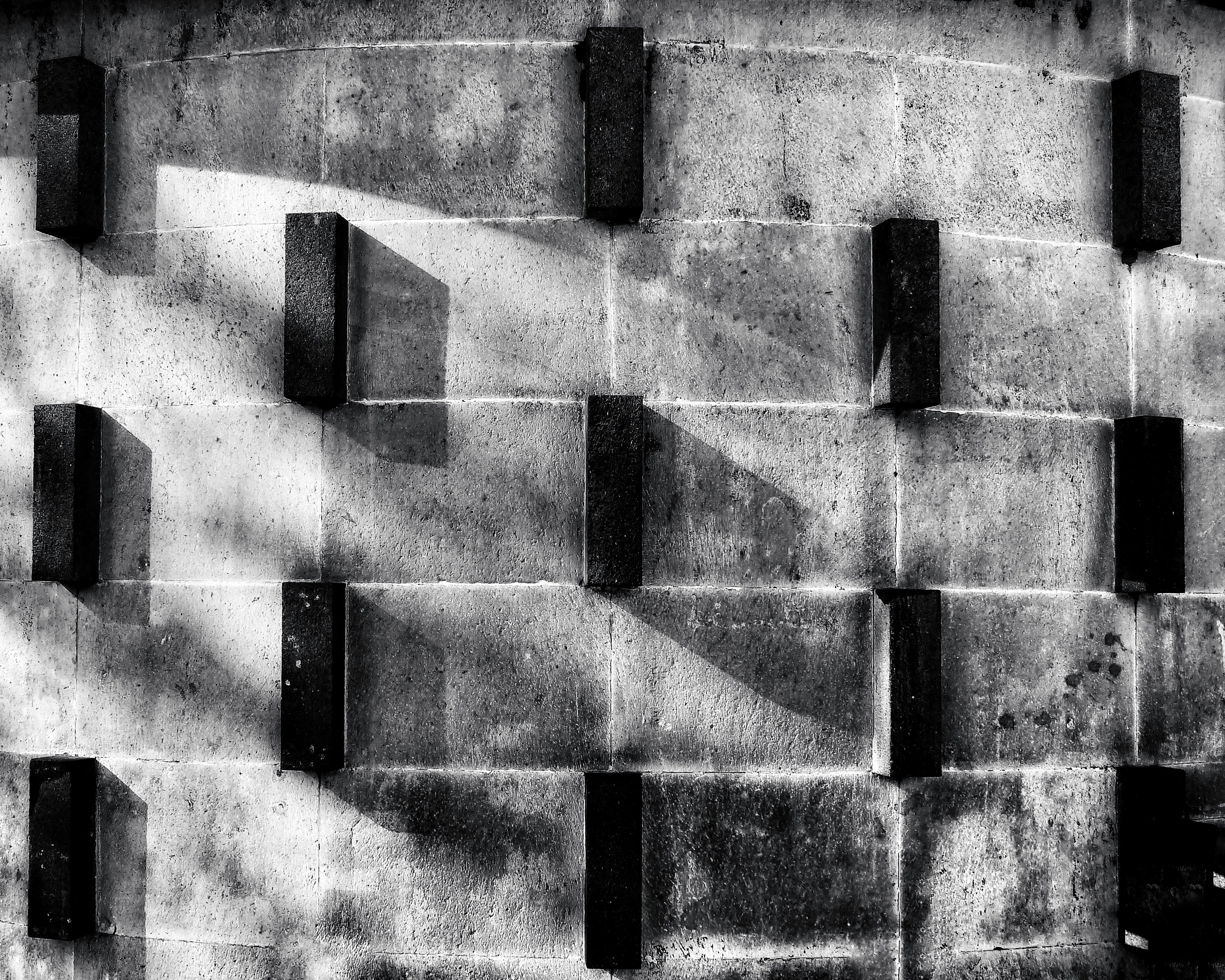 Shaded Blocks and Angled Light on a Weathered Facade