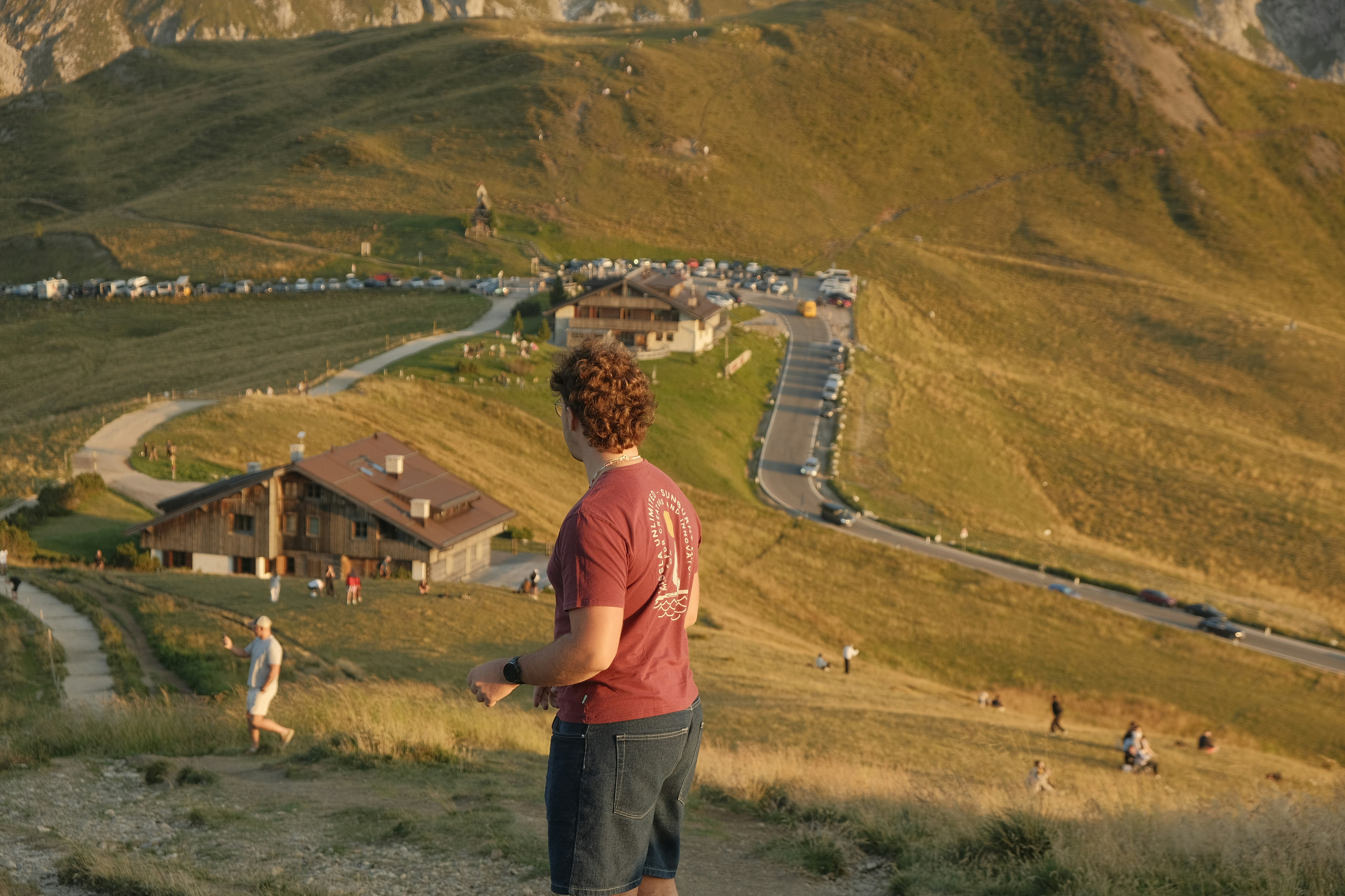 Hillside Meetup: A Red Shirt Turns Toward the Village Below