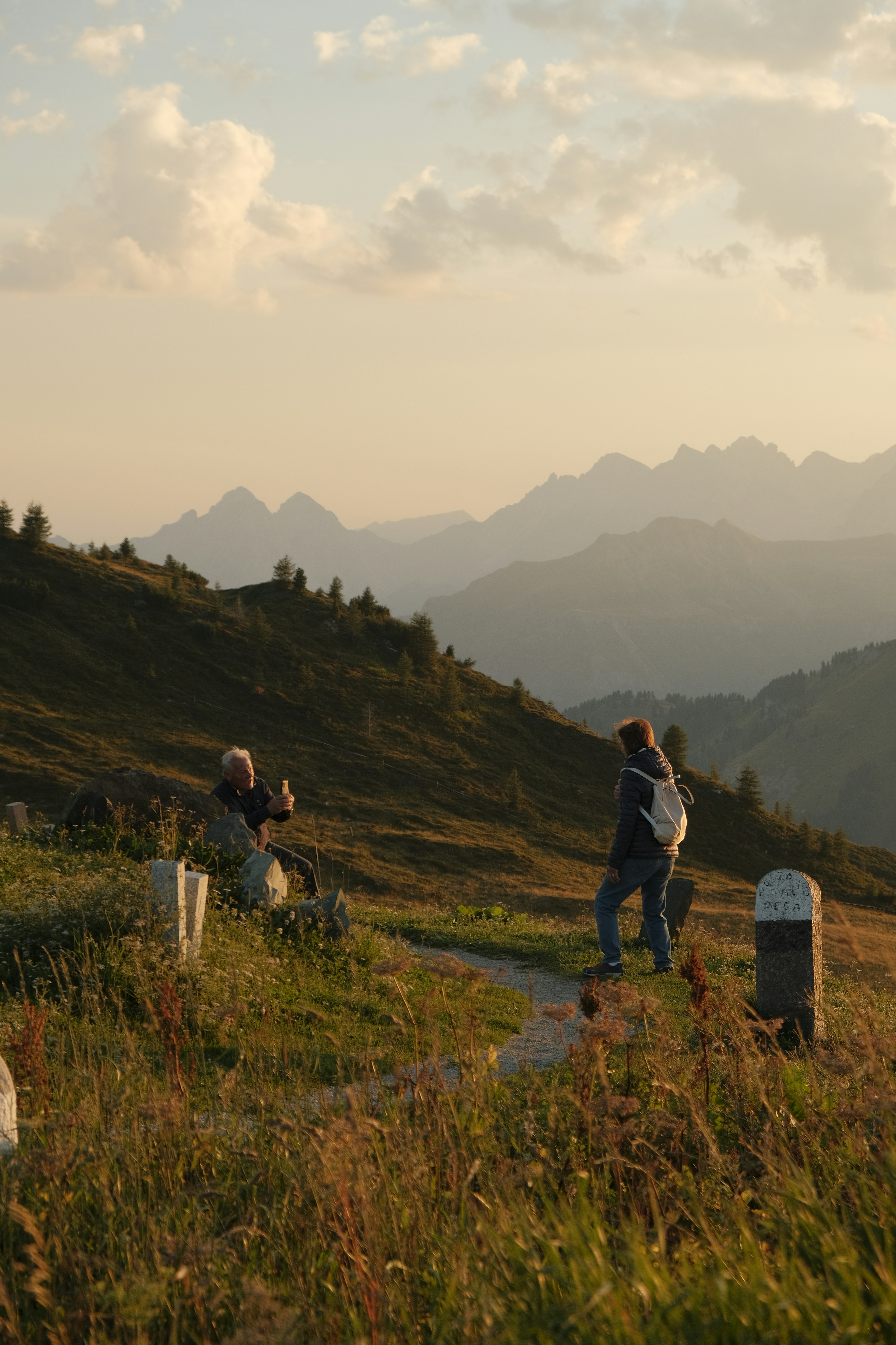 Hikers at a Sunset Over Alpine Ridge