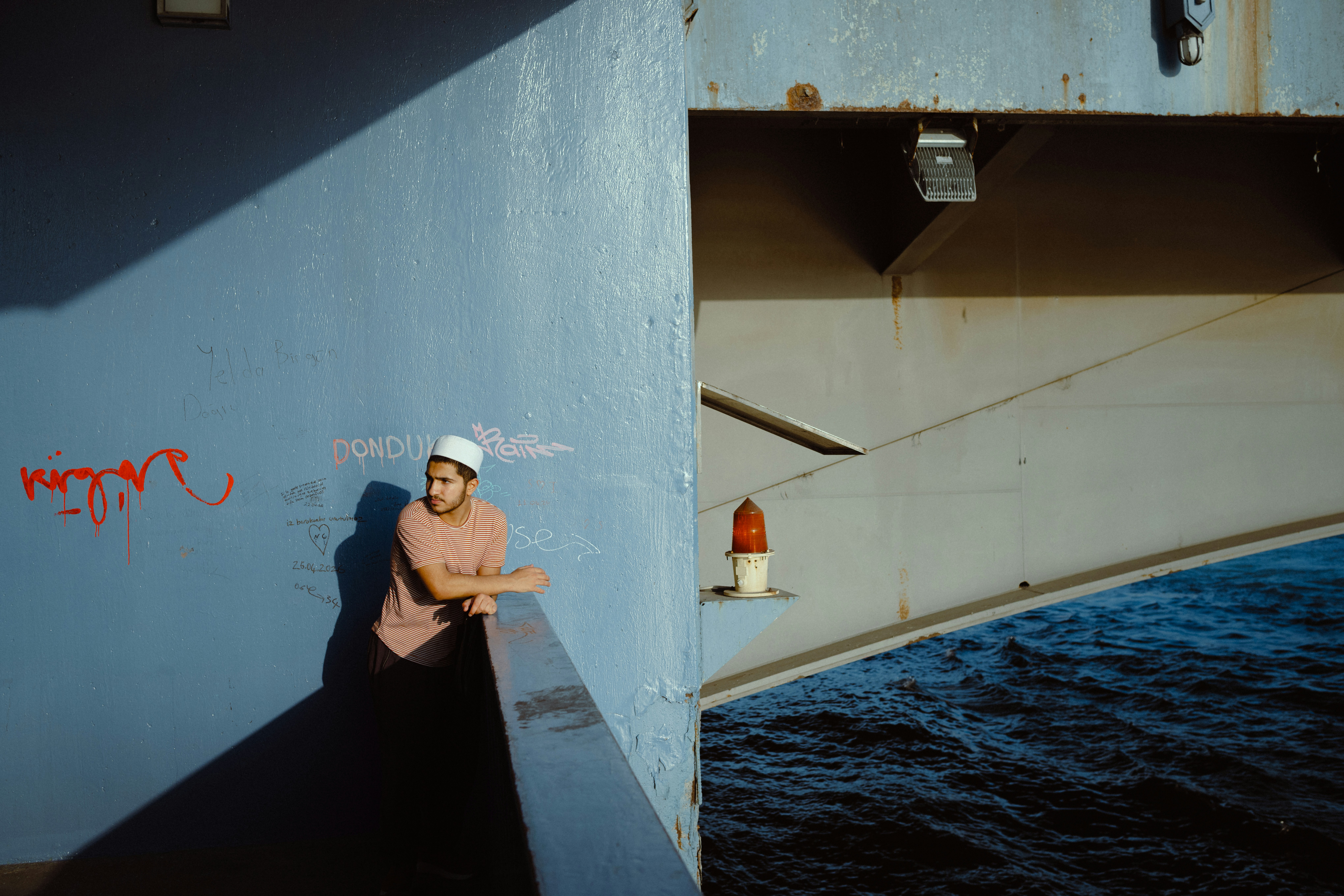 Shadowed Voyager at the Pier: A Portrait in Concrete and Sea