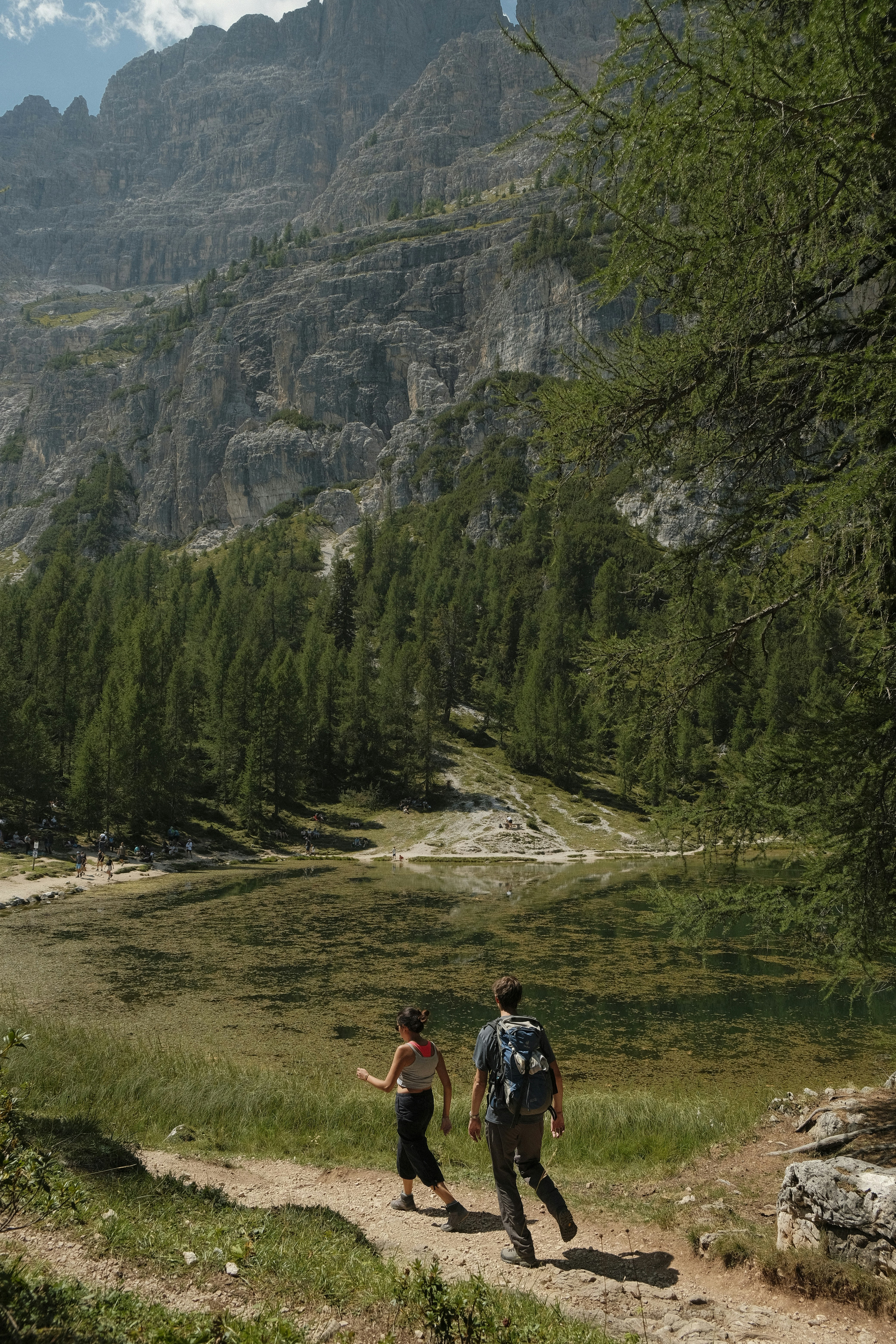 Hikers Trek Toward a Tranquil Alpine Lake