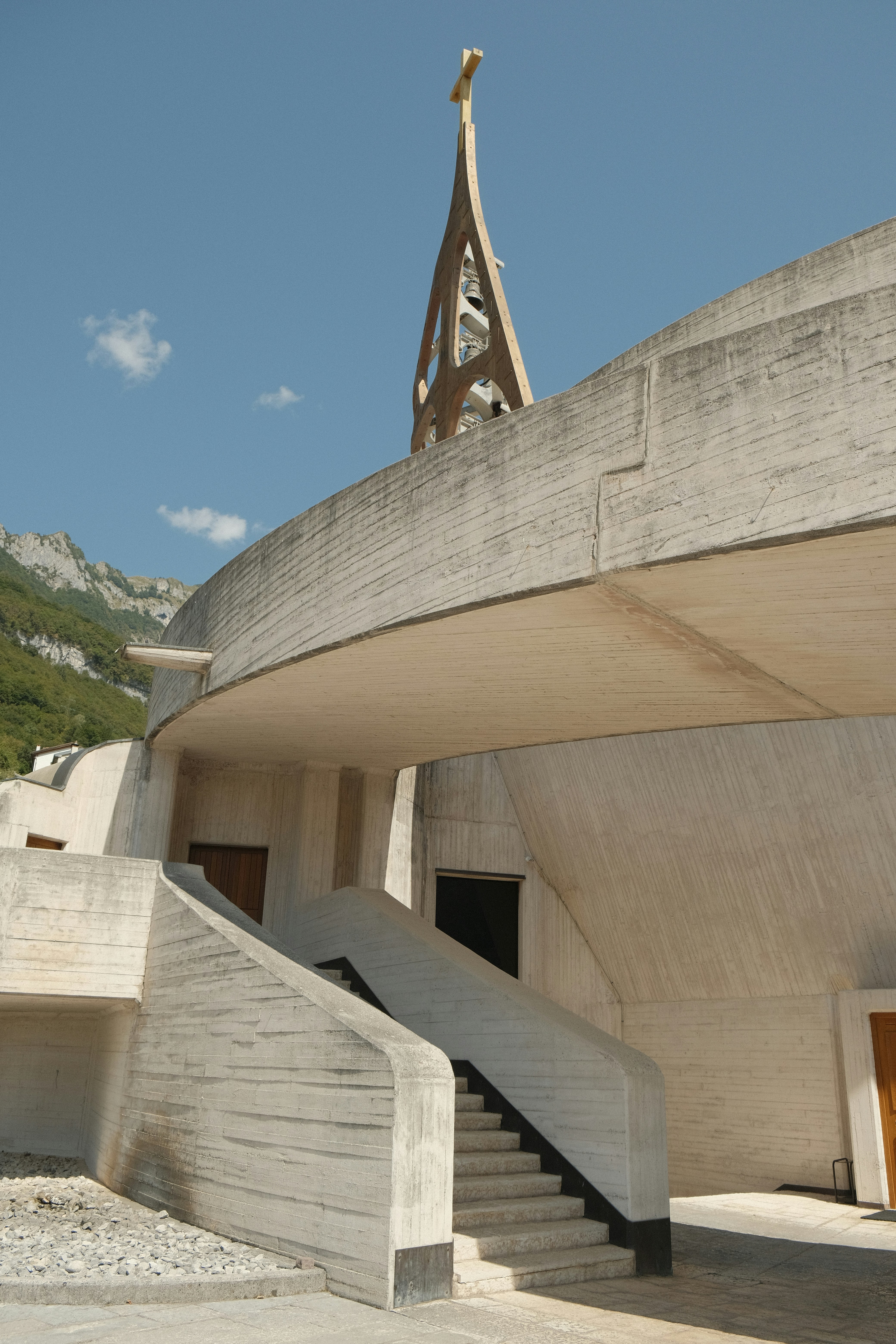 Winged Concrete Archway under a Clear Alpine Sky