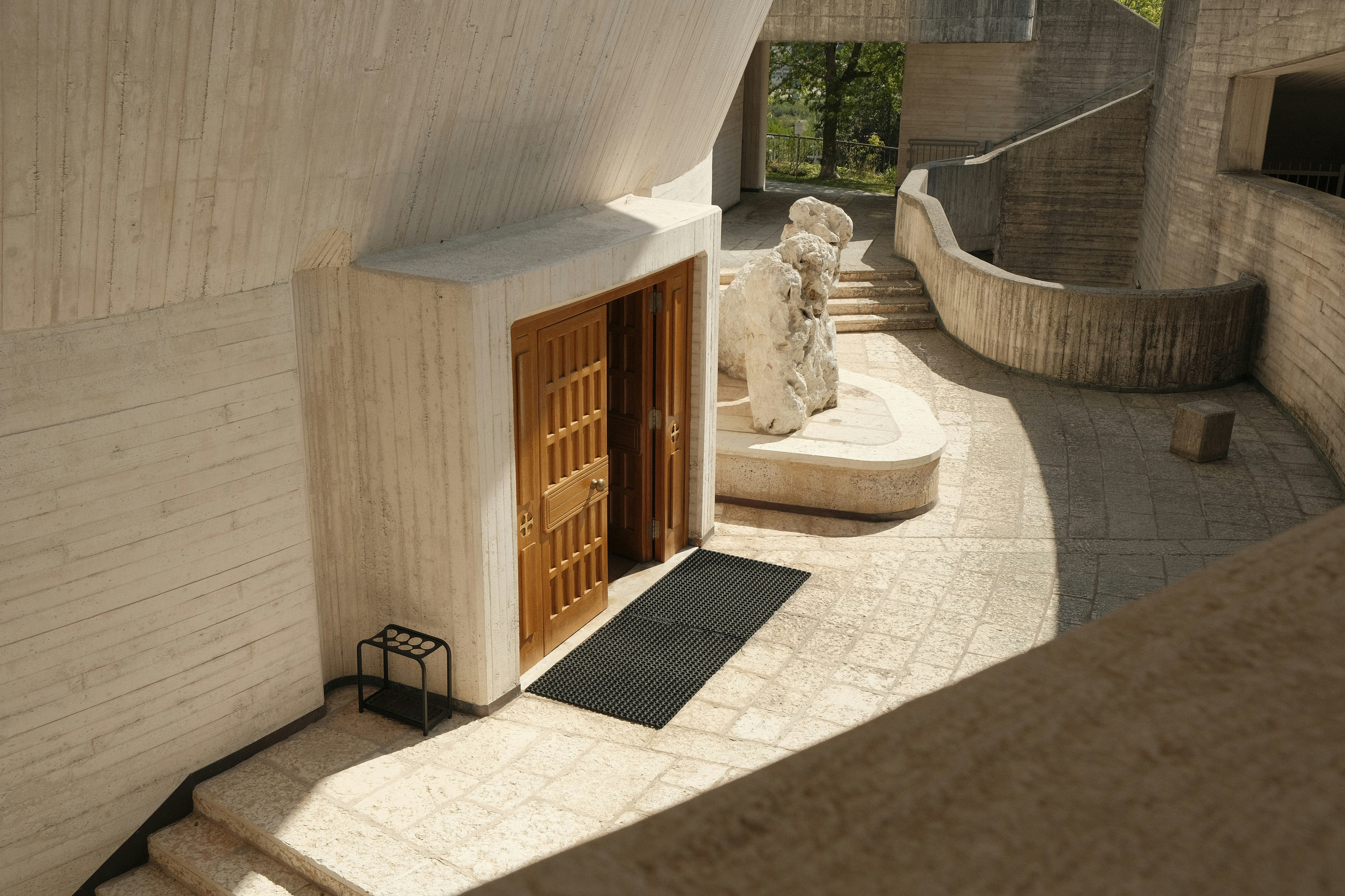Temple of Light: A Quiet Entrance in Curved Concrete