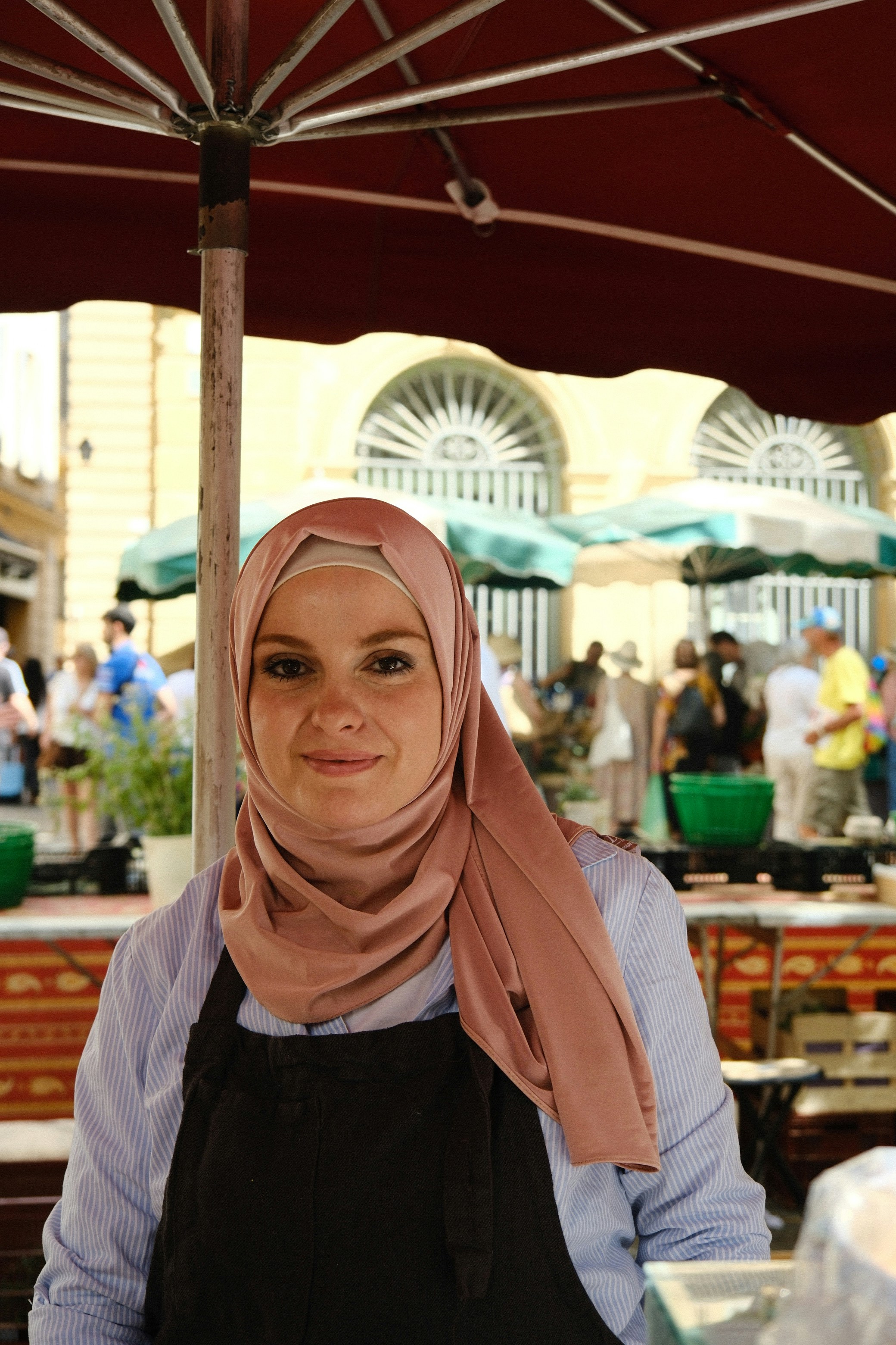 Market Portrait Under a Sunset Red Canopy