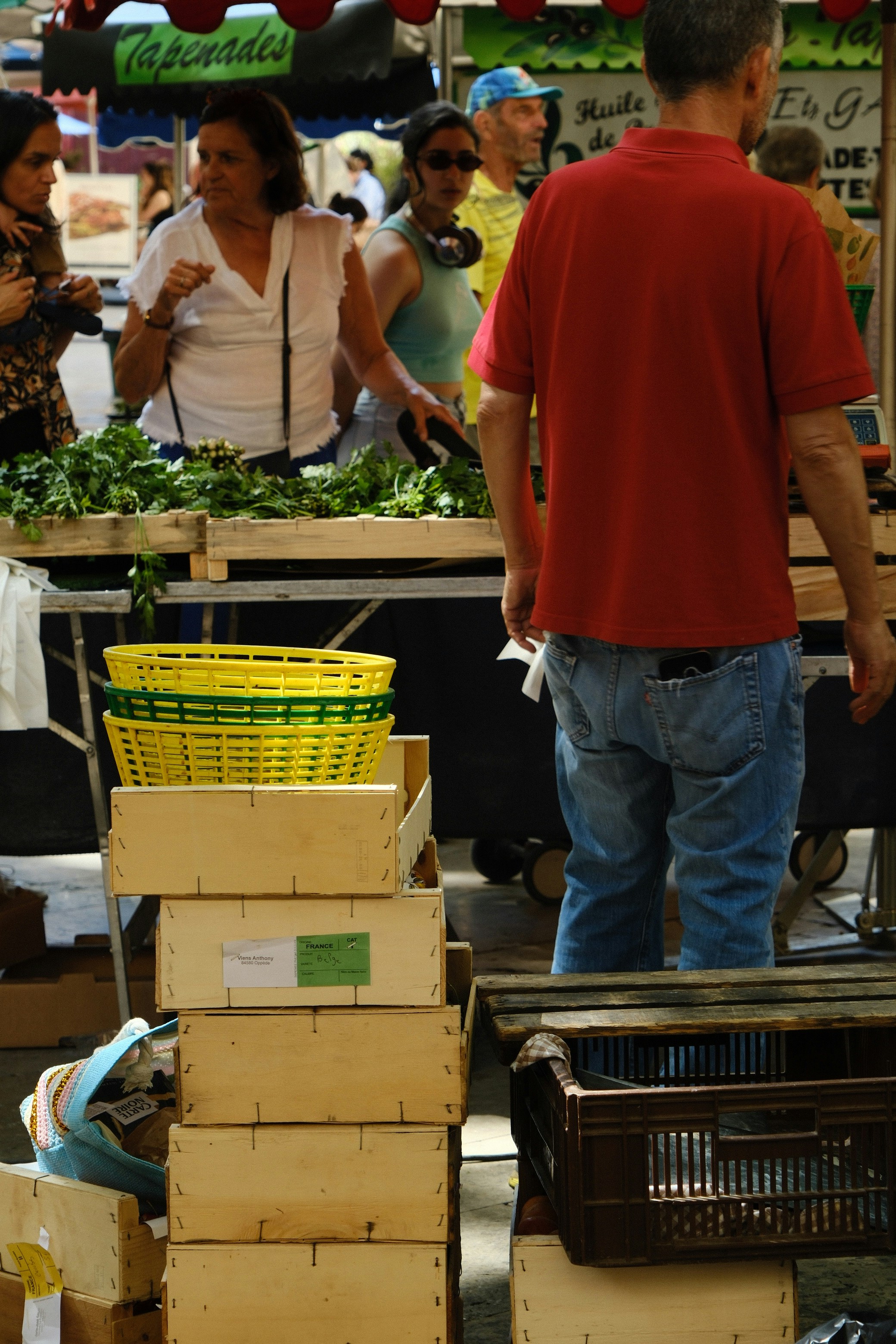 Market Portrait: Faces at a Bustling Outdoor Stand