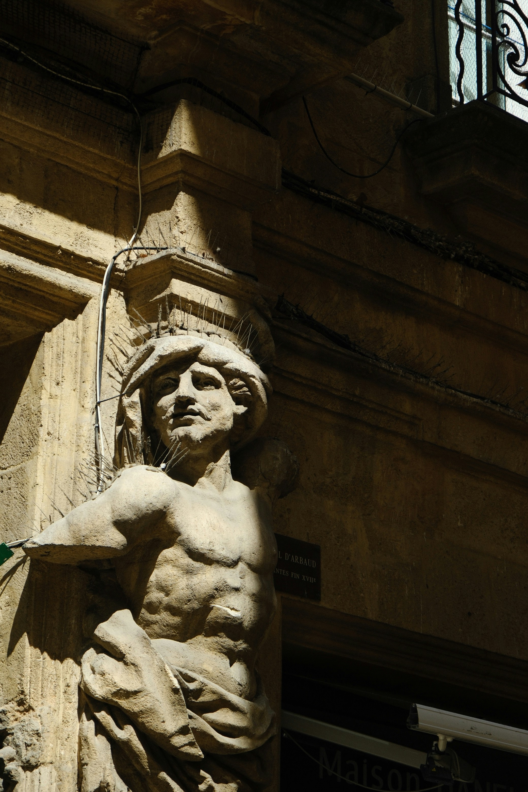 Stone Gargoyle in Warm Sunlight: A Quiet Facade Portrait
