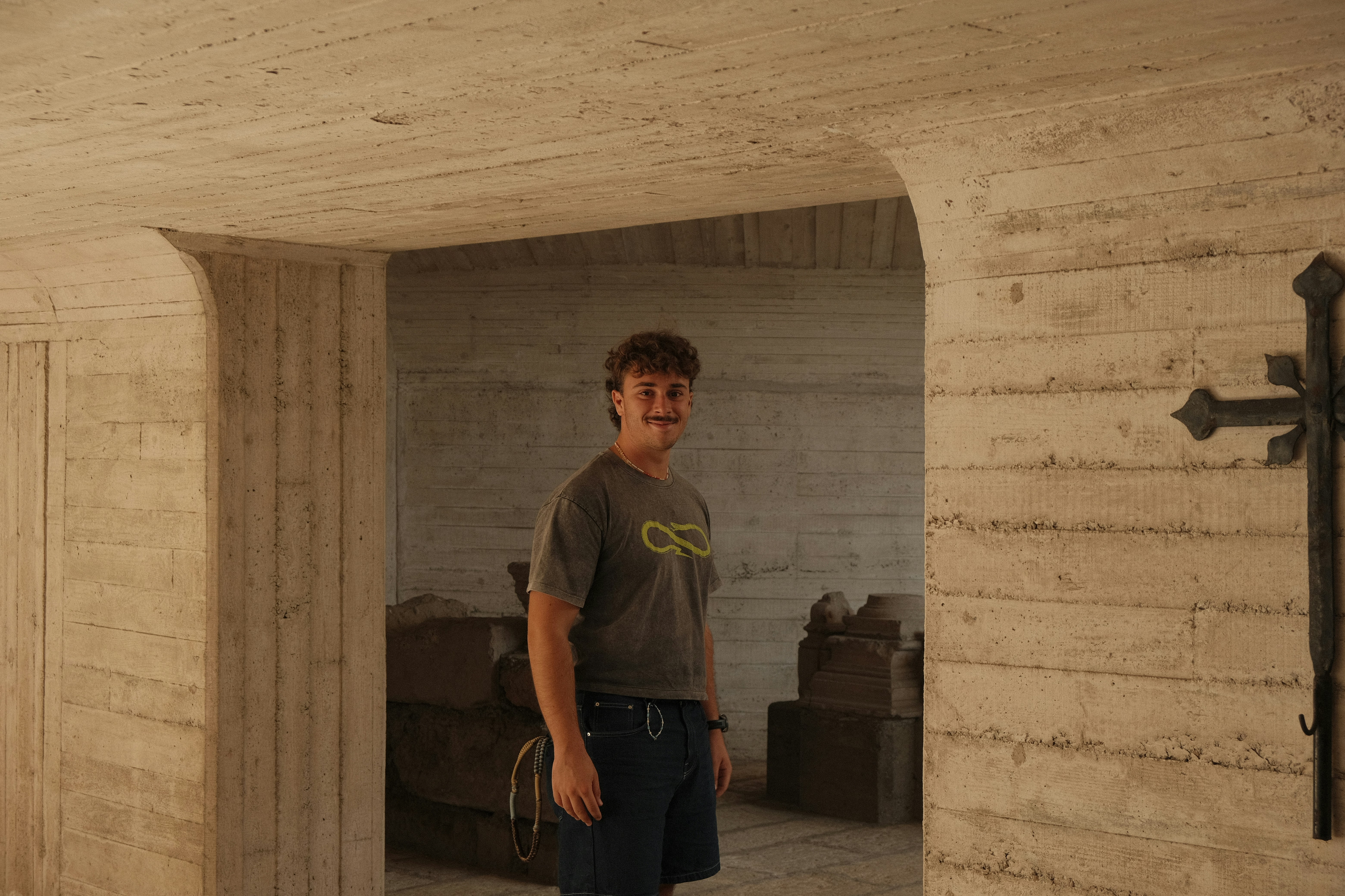 Man in a Concrete Corridor Under Soft Natural Light