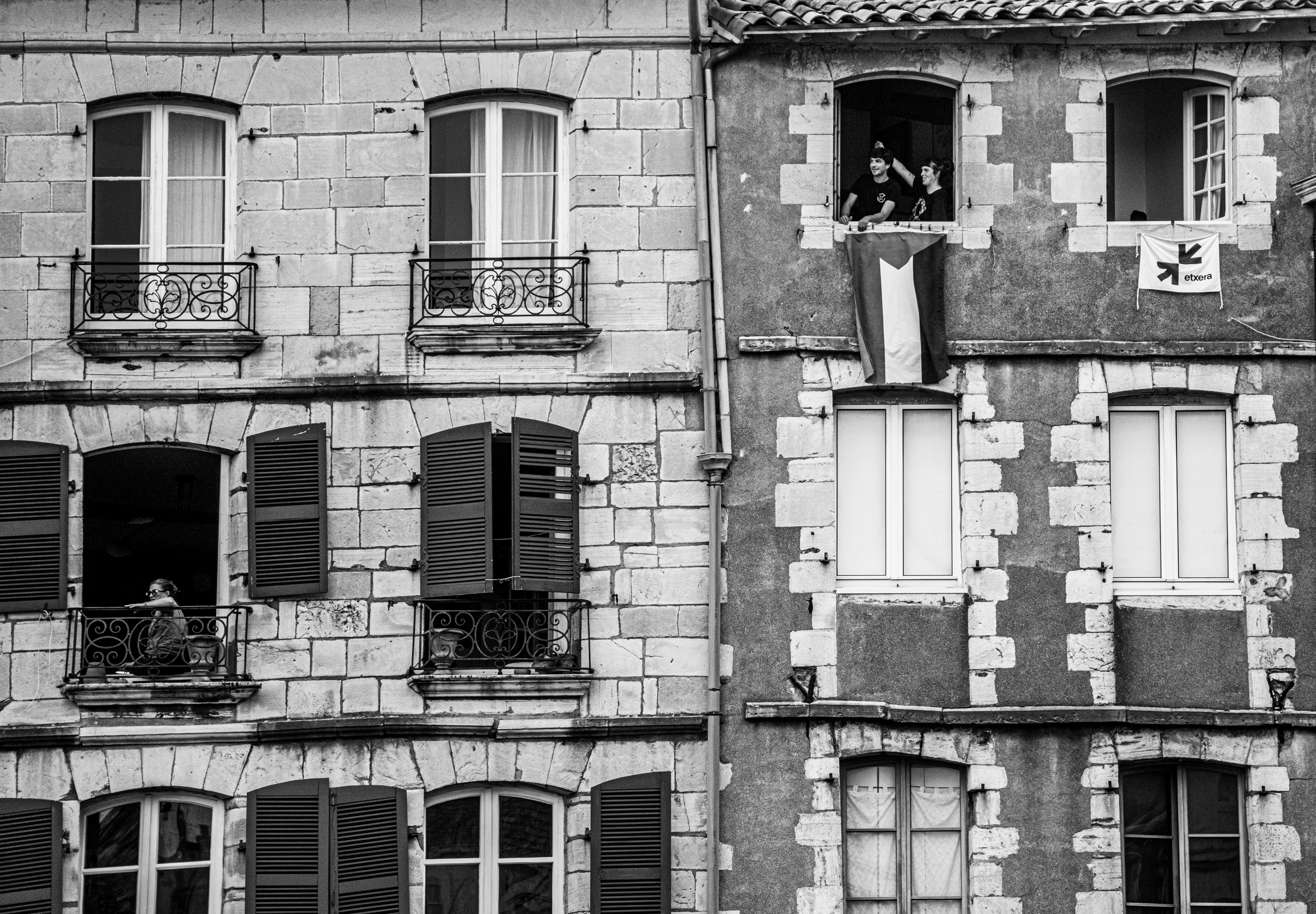Residents on the Lattice: Flags and Windows in a Stone Facade