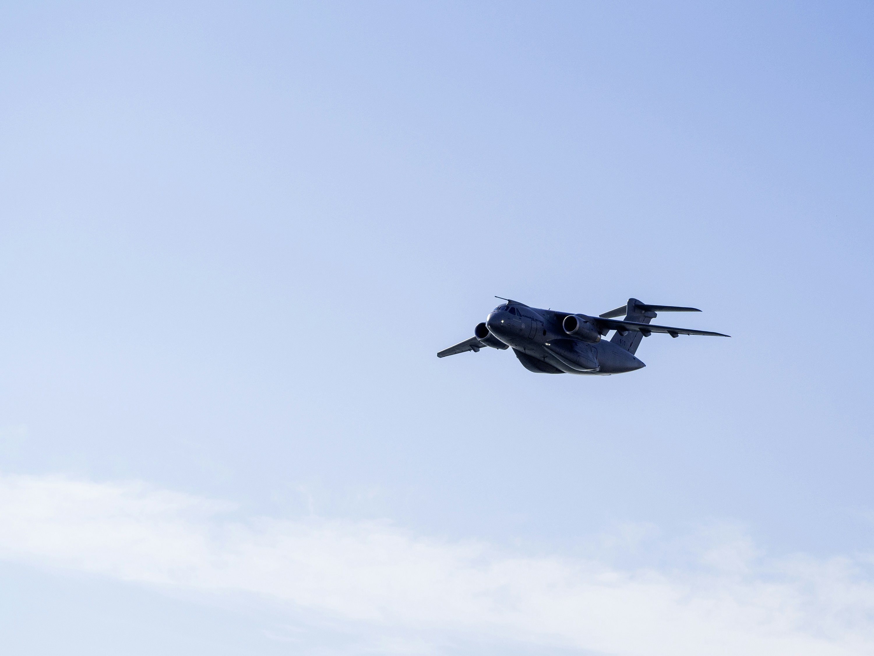 Blue Arrow: a high-contrast jet gliding through pale skies