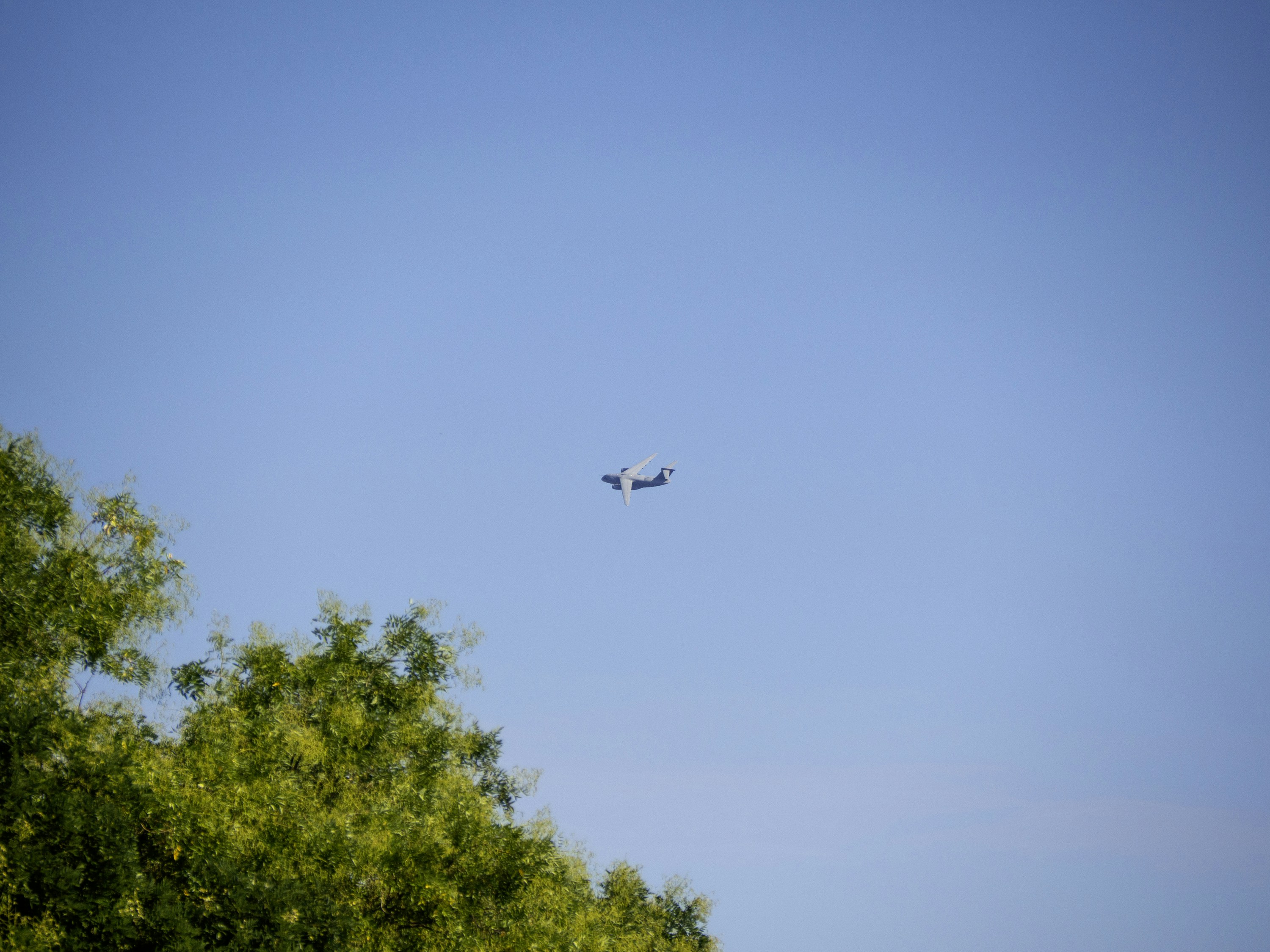  solitary jet carving a thin line across a blue sky