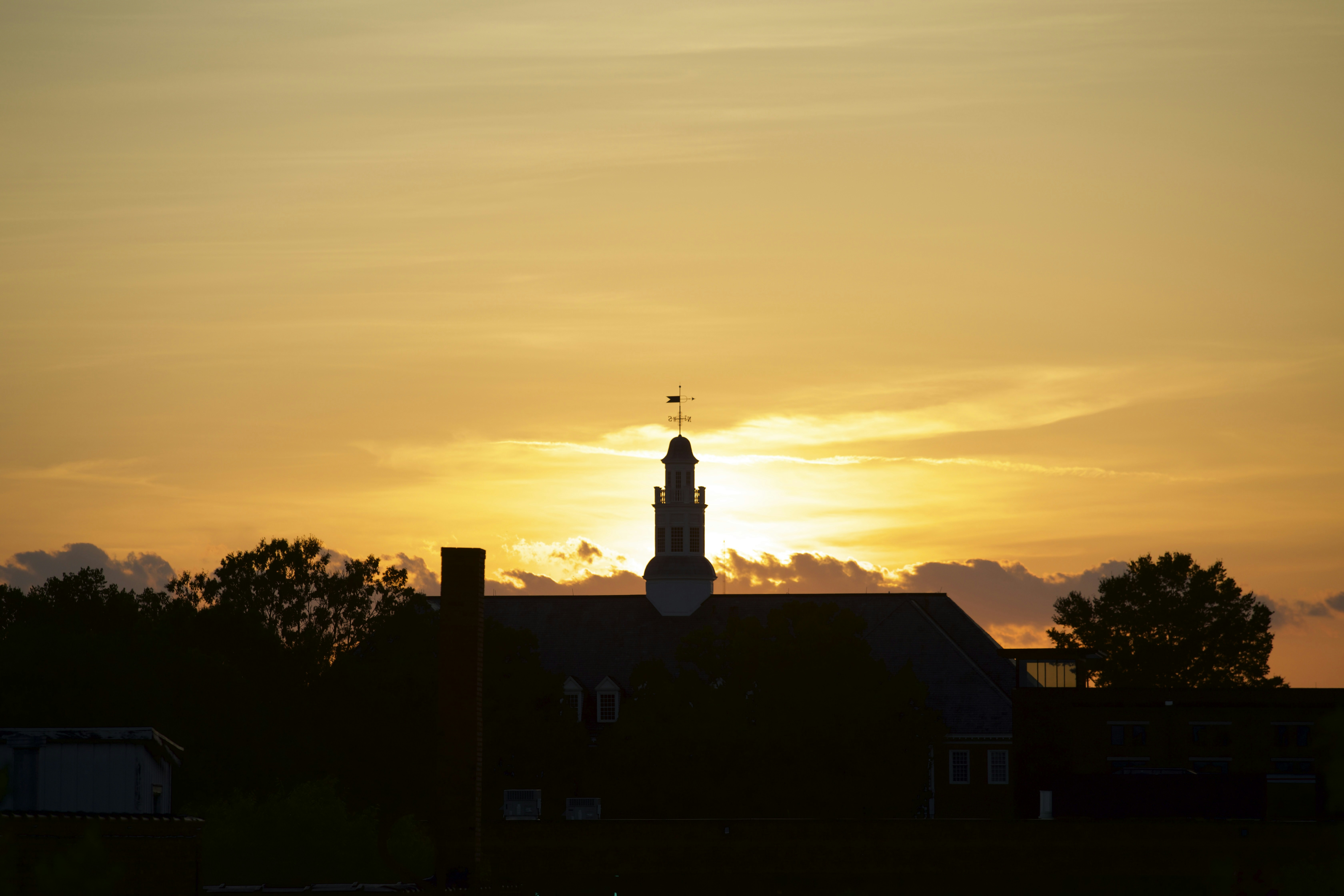 Sunset lining up with the office building of the First Citizen's Bank downtown Greenville.