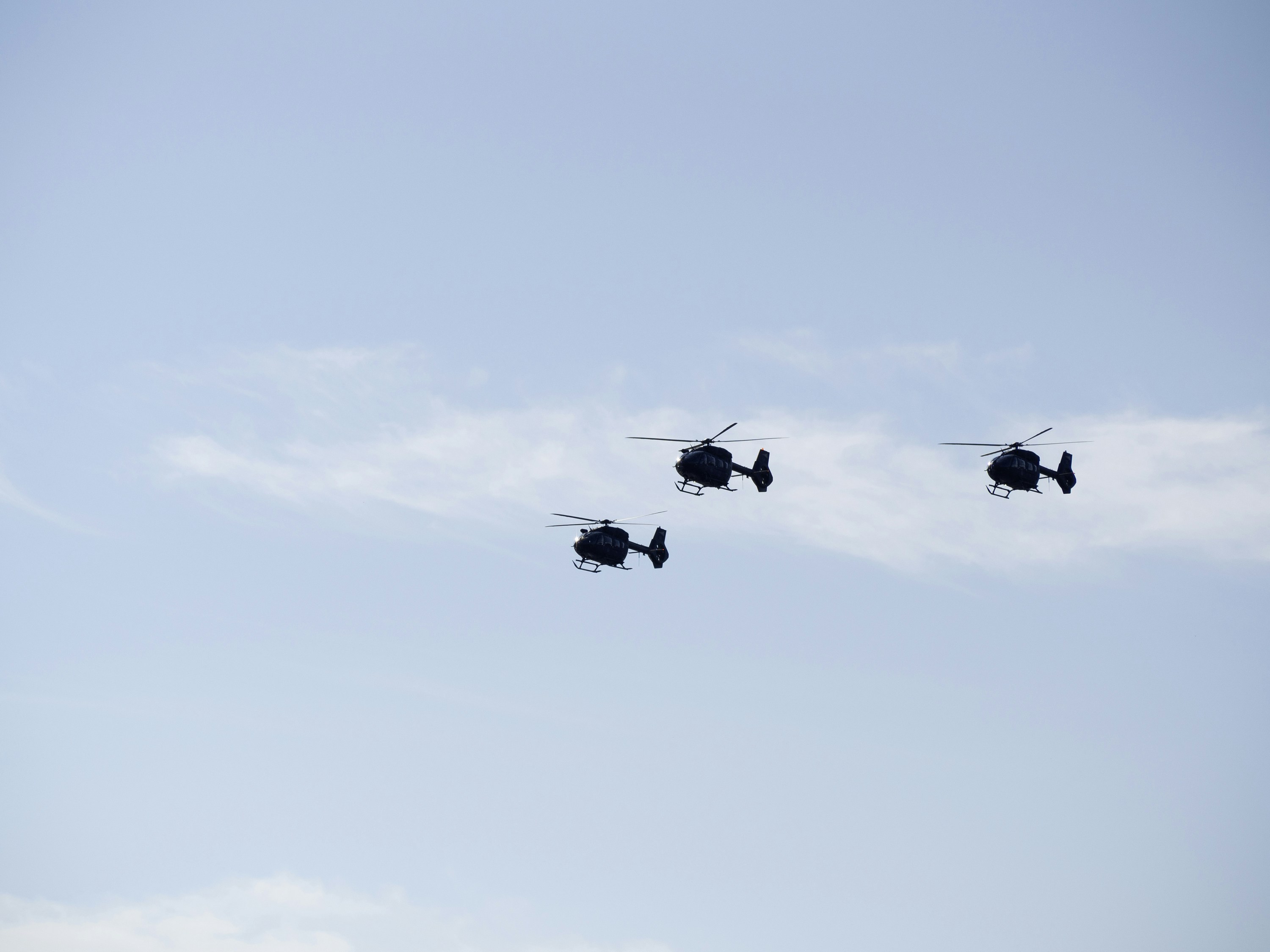 Triumph in the Sky: A Chevron of Choppers Crossing a Clear Afternoon