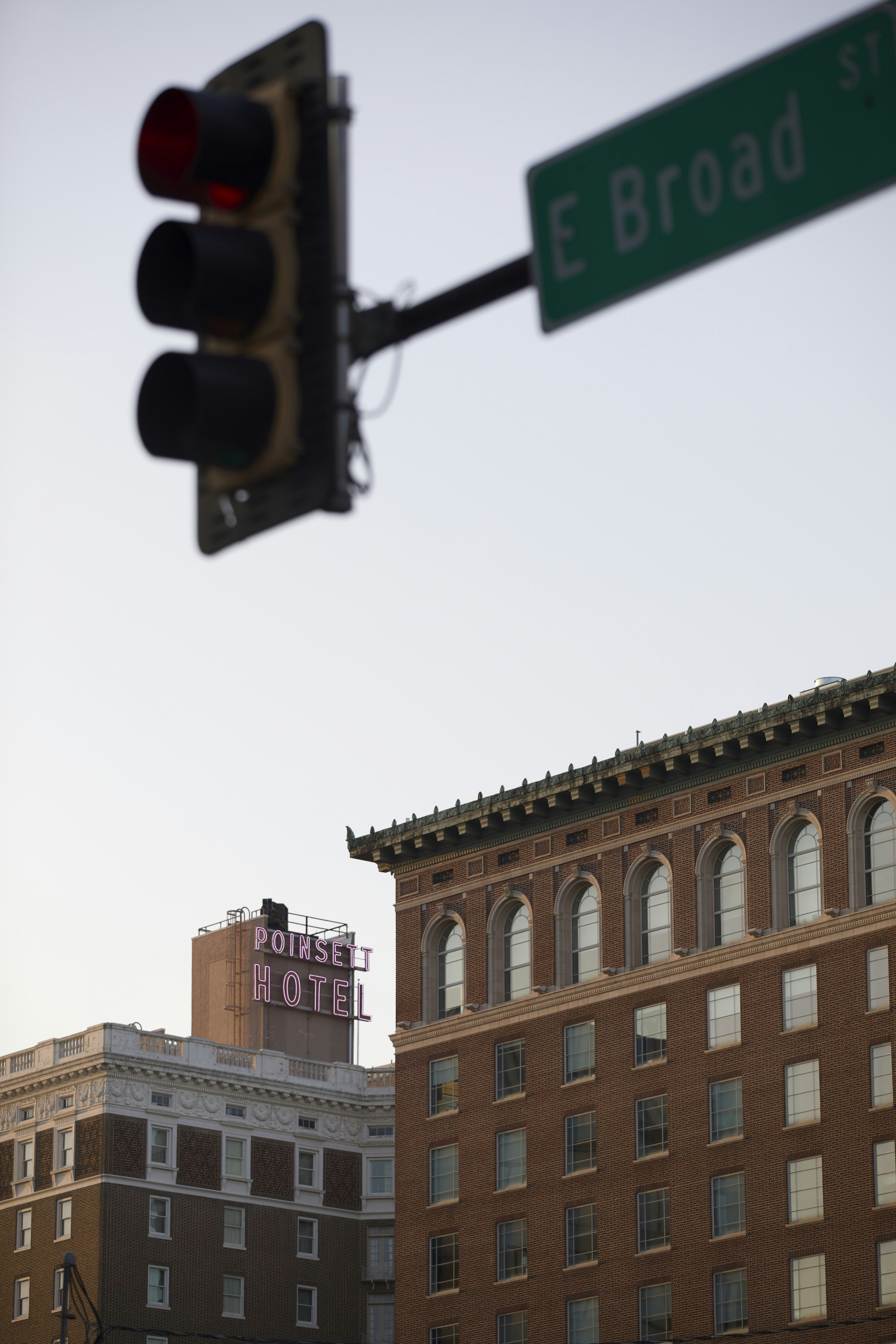 Urban Crossroads: The Red Sign, Green Street, and Brick Facades