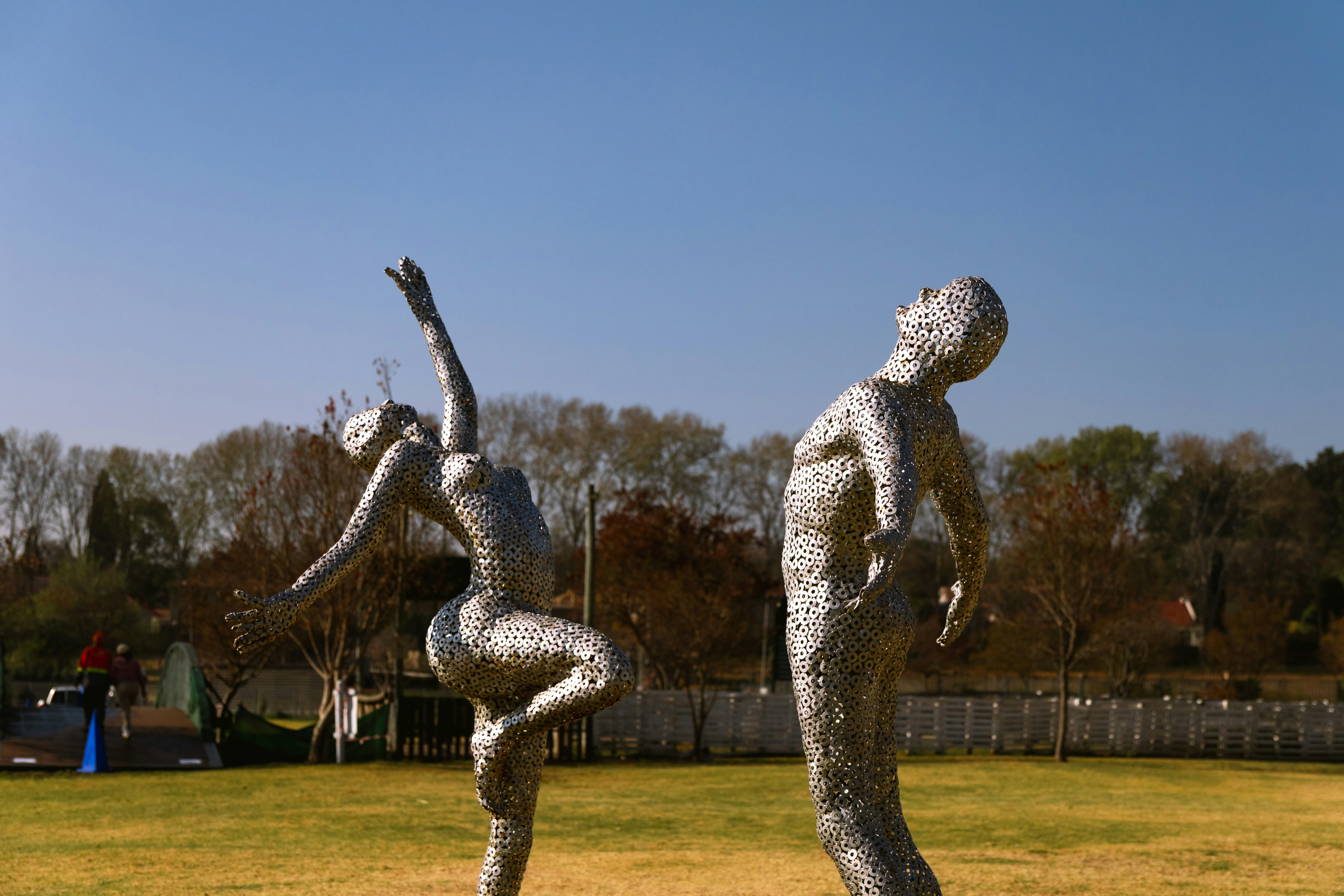 Dot-Clad Dancers in a Sunlit Park